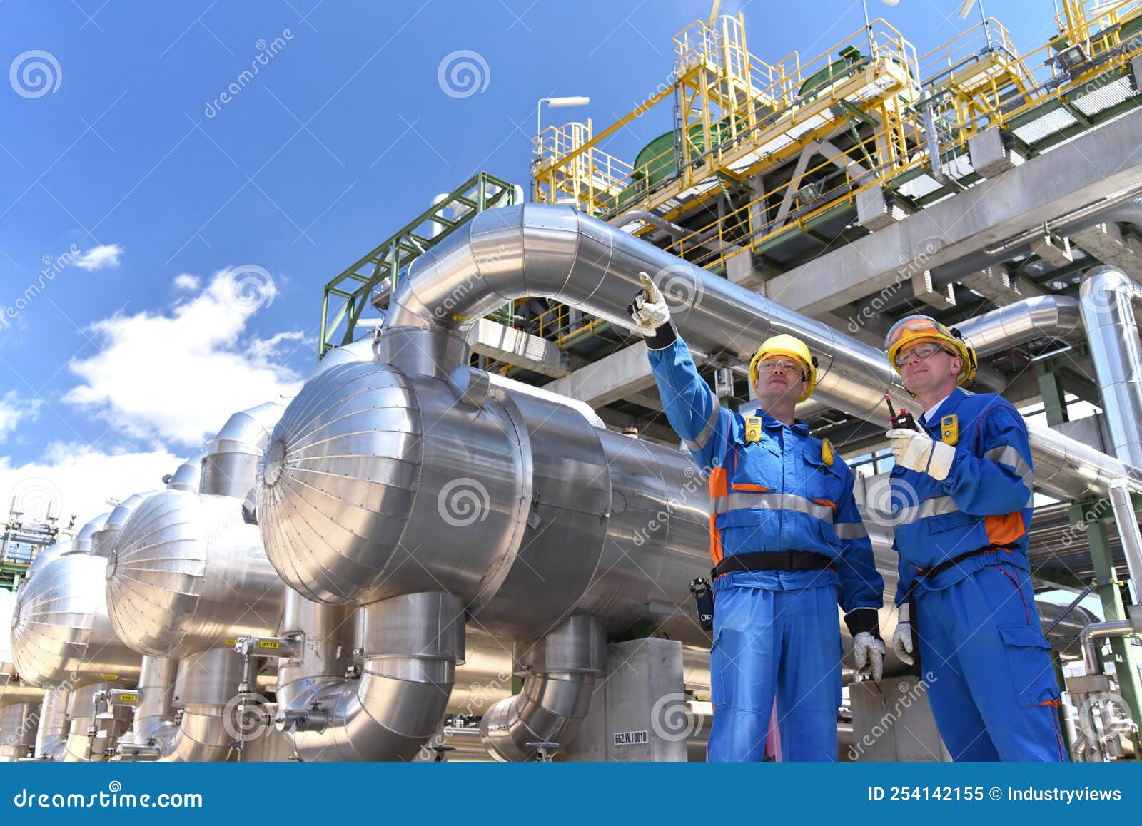 Teamwork: Group of Industrial Workers in a Refinery - Oil Processing ...