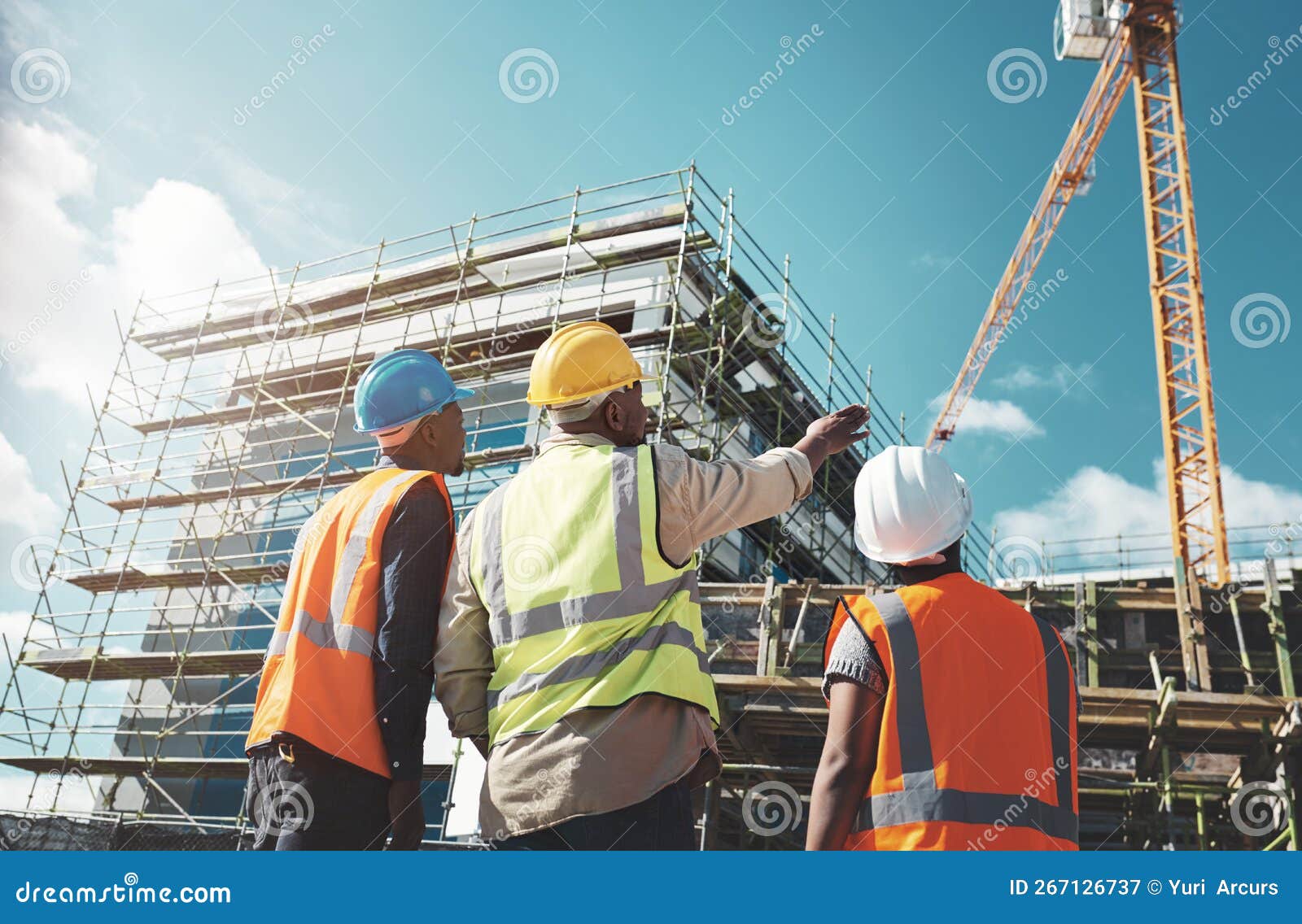 Teamwork is the Key Ingredient in Quality Construction. a Group of Builders Assessing Progress ...