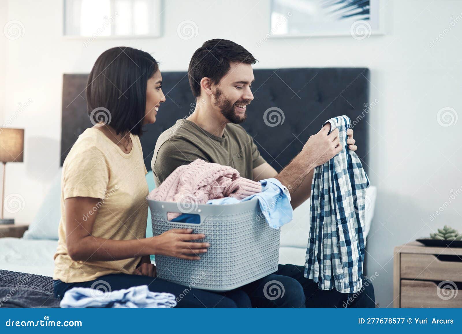 Teamwork Lightens the Load. a Young Couple Doing Laundry Together at ...