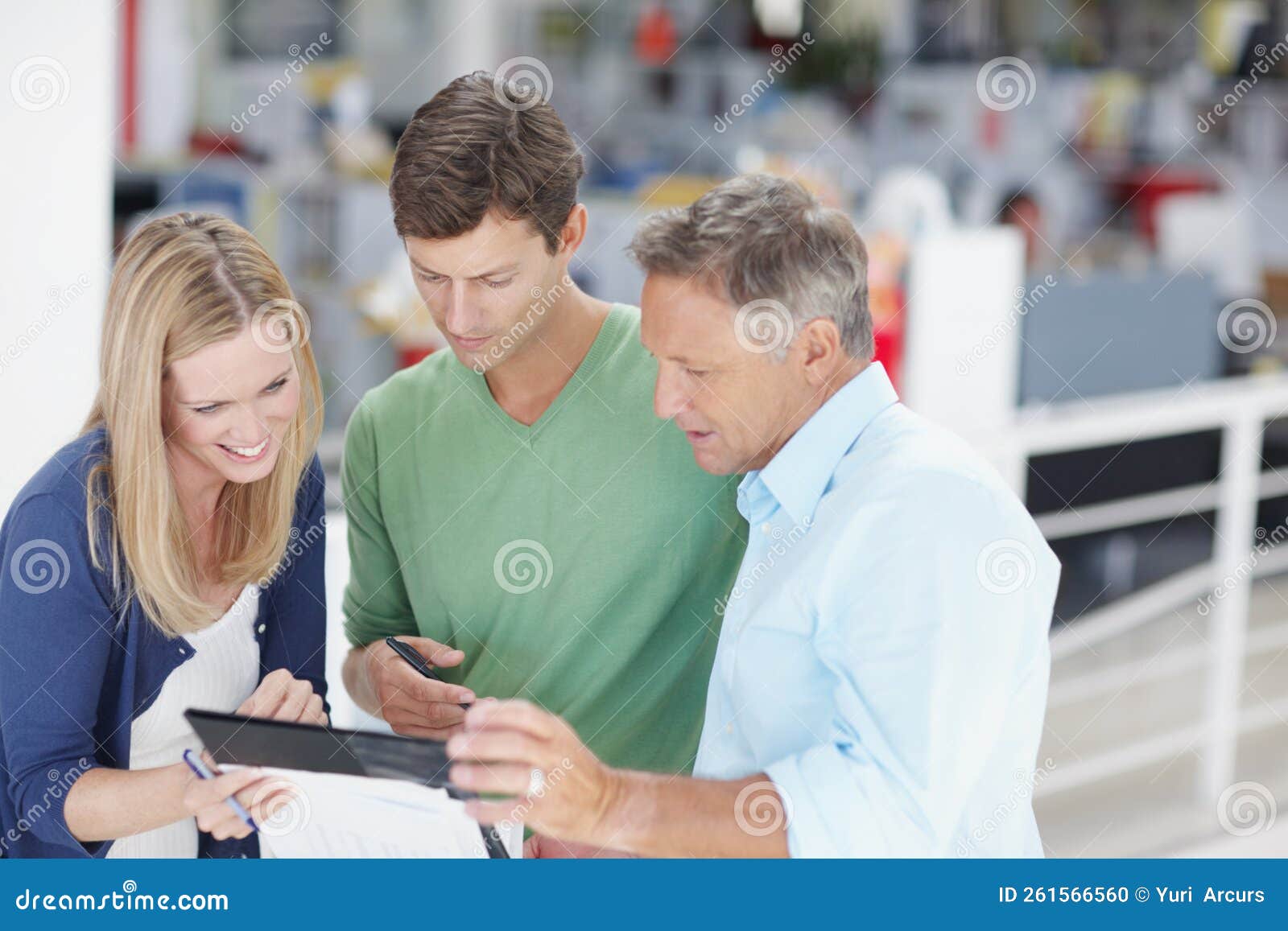 Teamwork Makes the Load Lighter. Three Work Colleagues Discussing ...