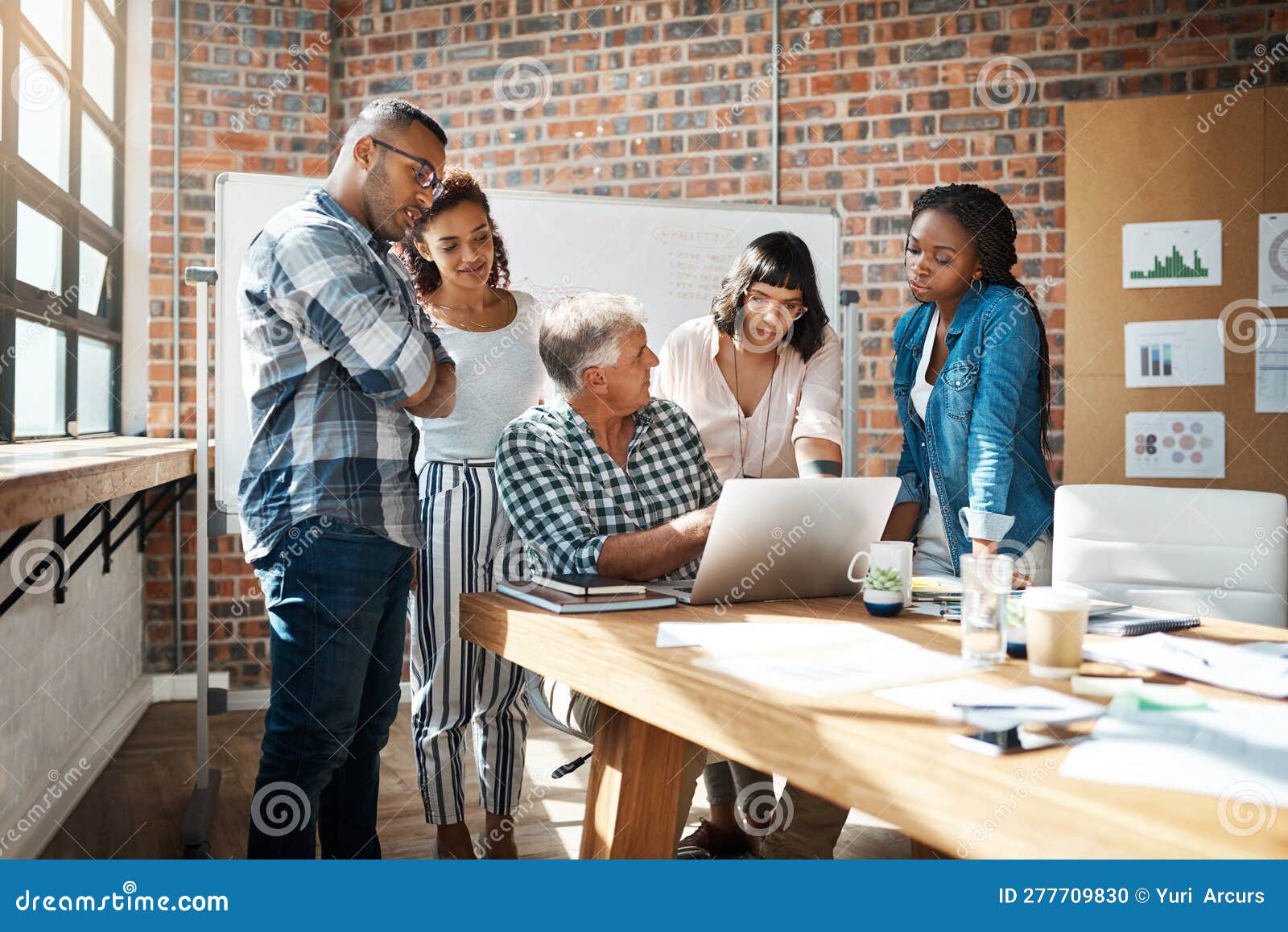 Teamwork Makes the Task Work. a Group of Colleagues Using a Laptop ...