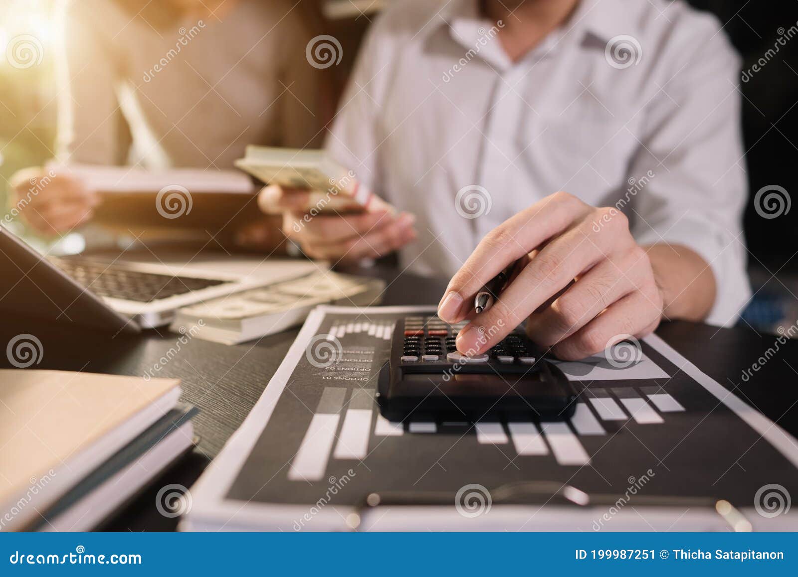 Teamwork Process, Business Team Using a Calculator To Calculate the ...