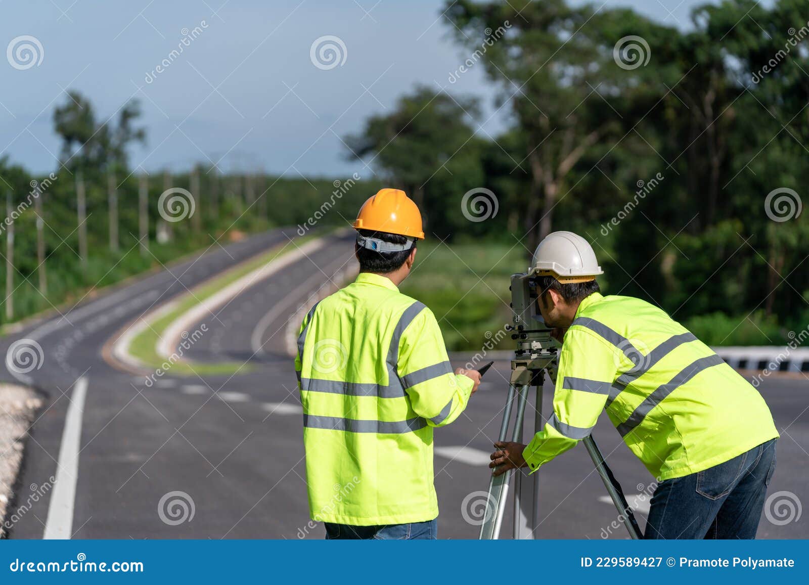 Teamwork of Surveyor Engineers with Equipment on Road Construction Site ...