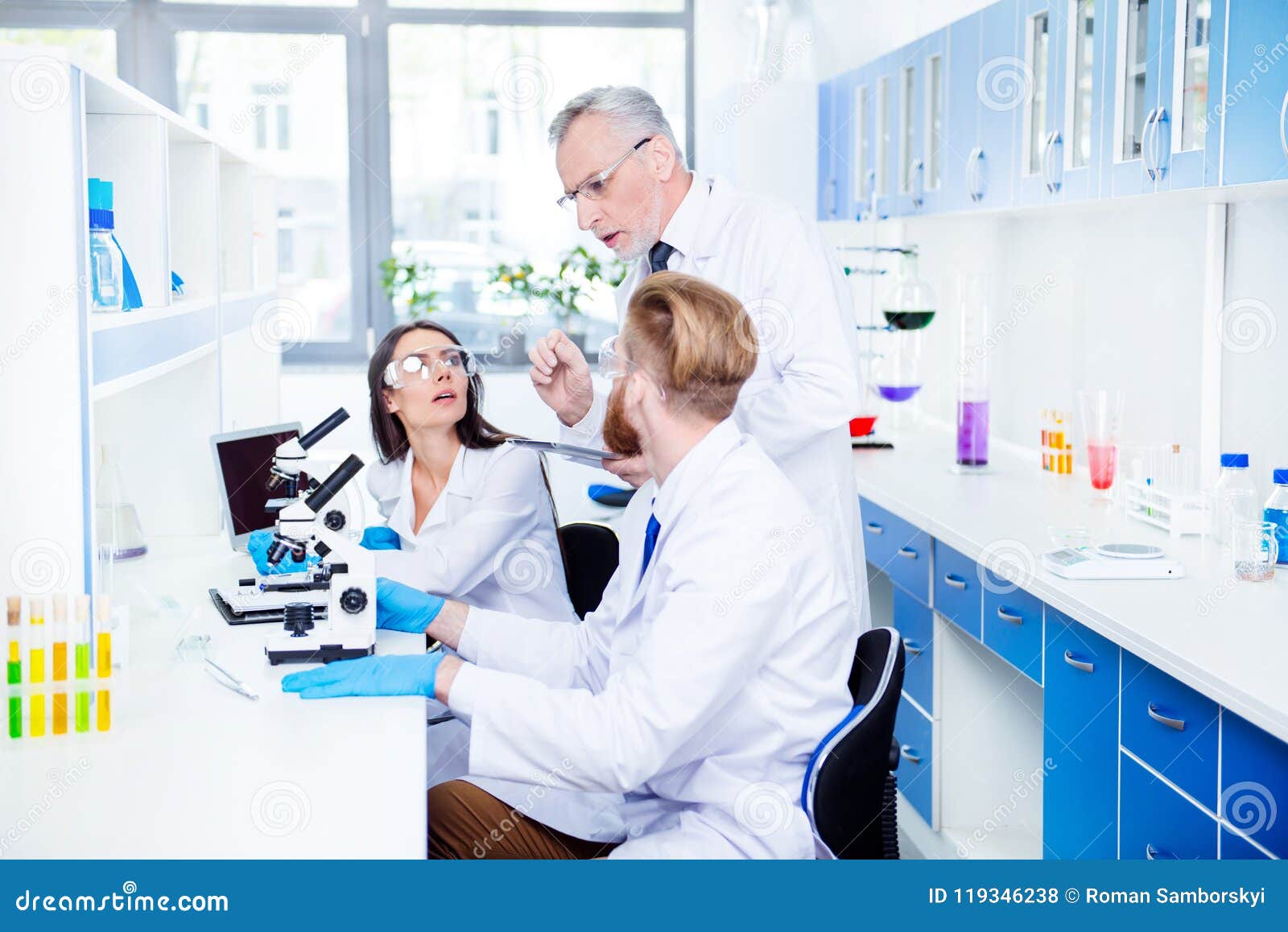 Teamwork and Teambuilding Concept. a Group of Three Scientists I Stock ...