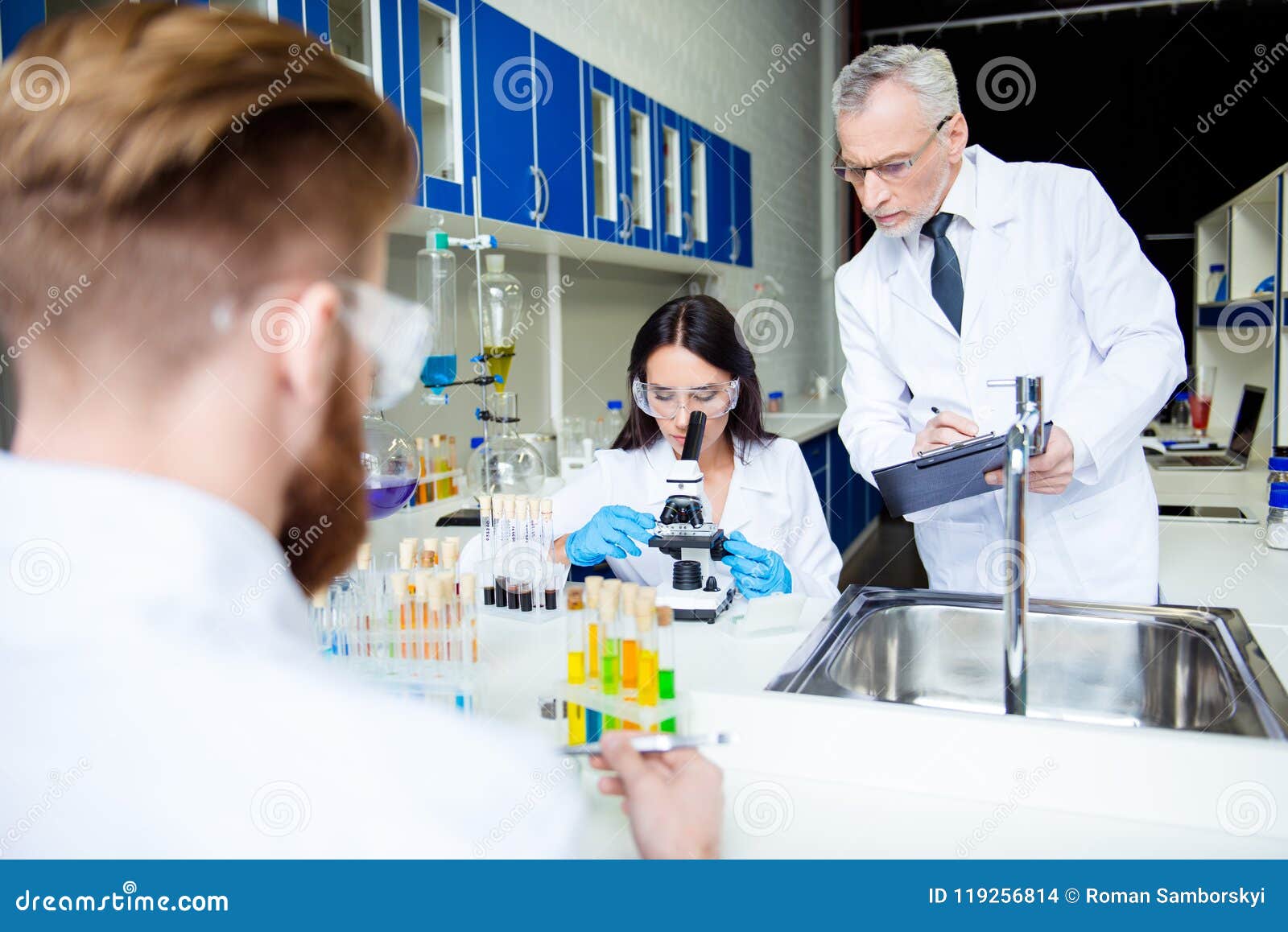 Teamwork and Teambuilding Concept. a Group of Three Scientists I Stock ... Teamwork and Teambuilding Concept. a Group of Three Scientists I Stock ...