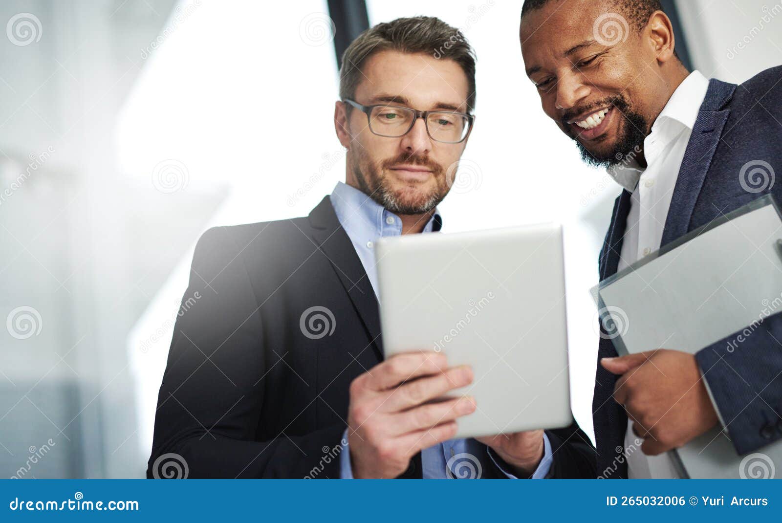 Teamwork and Technology - Key Contributors To Success. Two Businessmen ...