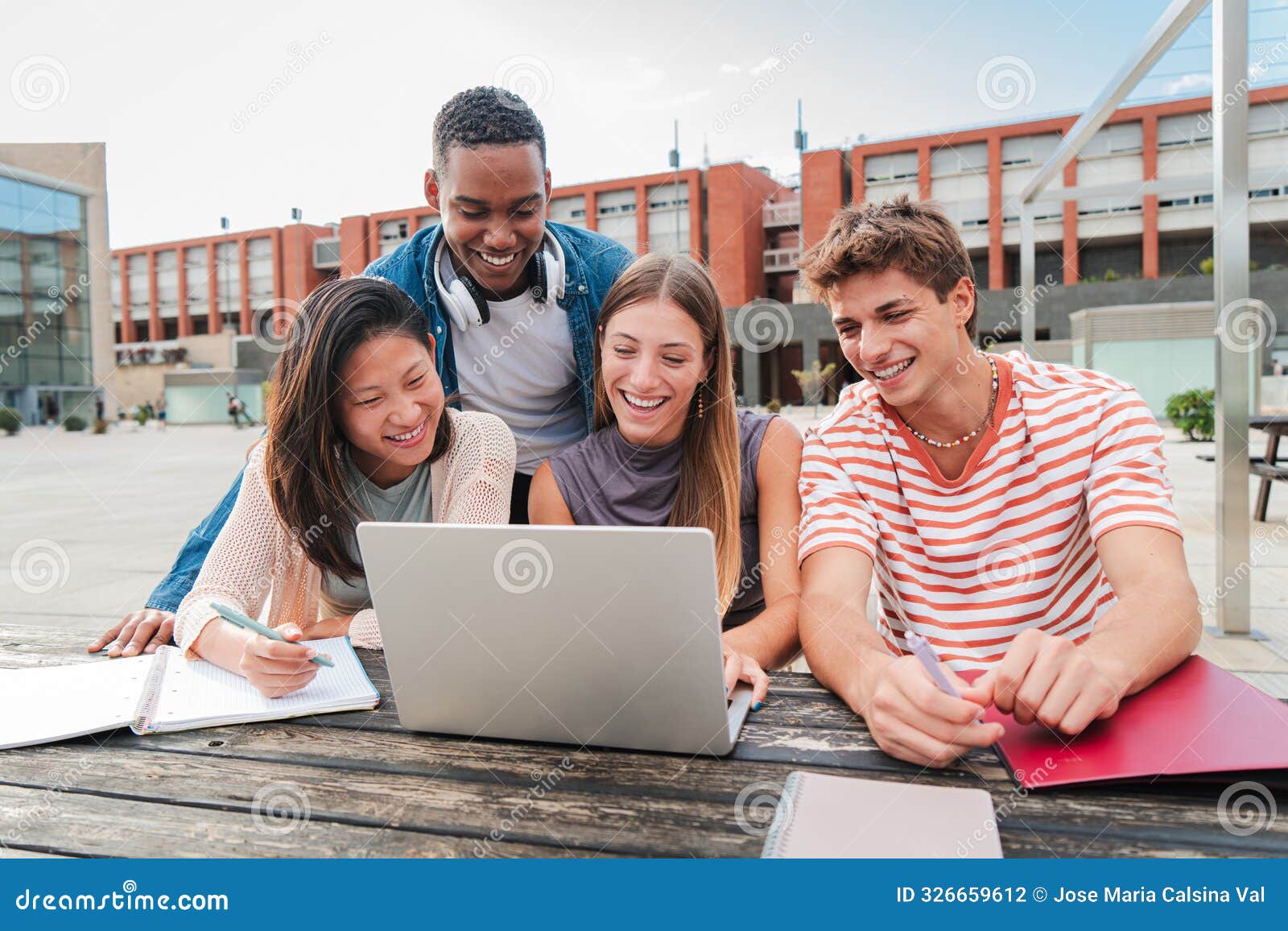 Teamwork of Teenage Students Using a Laptop To Prepare a Exam. Group of ...