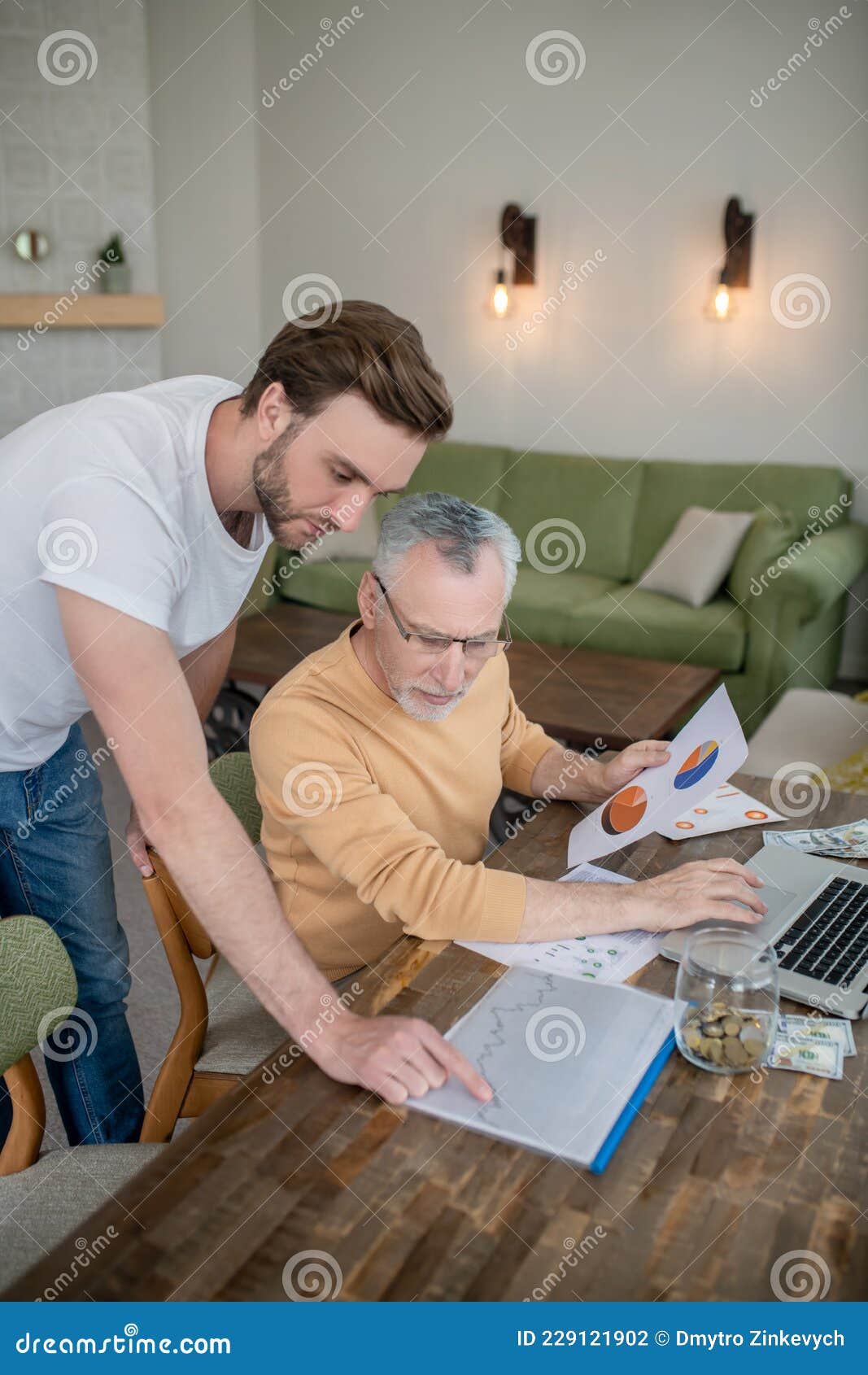 Two Men Working Together on a Project and Looking Involved Stock Photo ...