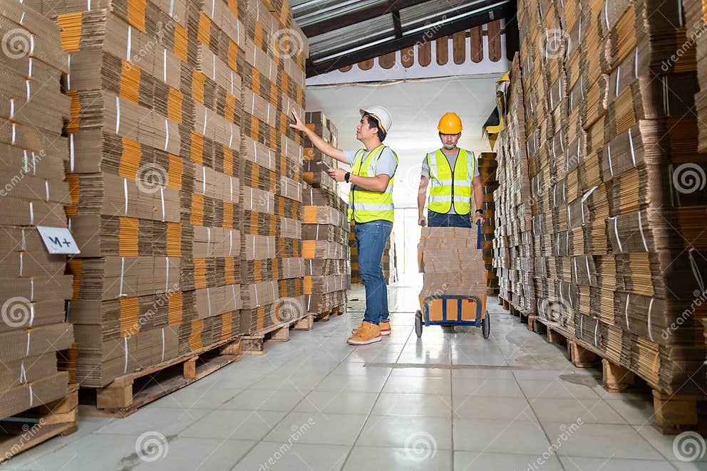 Teamwork of Workers in Warehouse Preparing Goods Cardboard Boxes on a ...