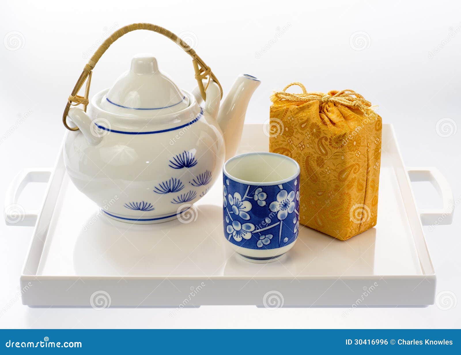Teapot and Cup with a Package of Tea Stock Photo - Image of yellow ...
