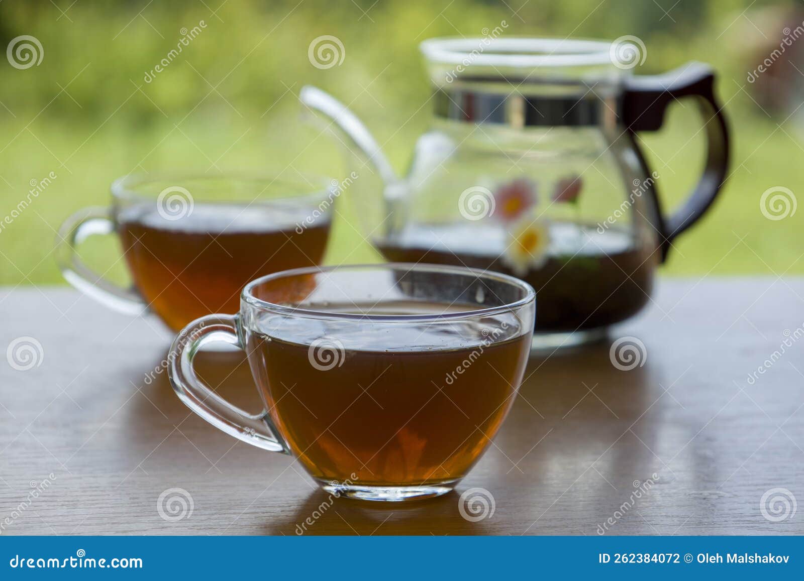 Teapot with a Transparent Cup of Tea in Nature Stock Photo - Image of ...