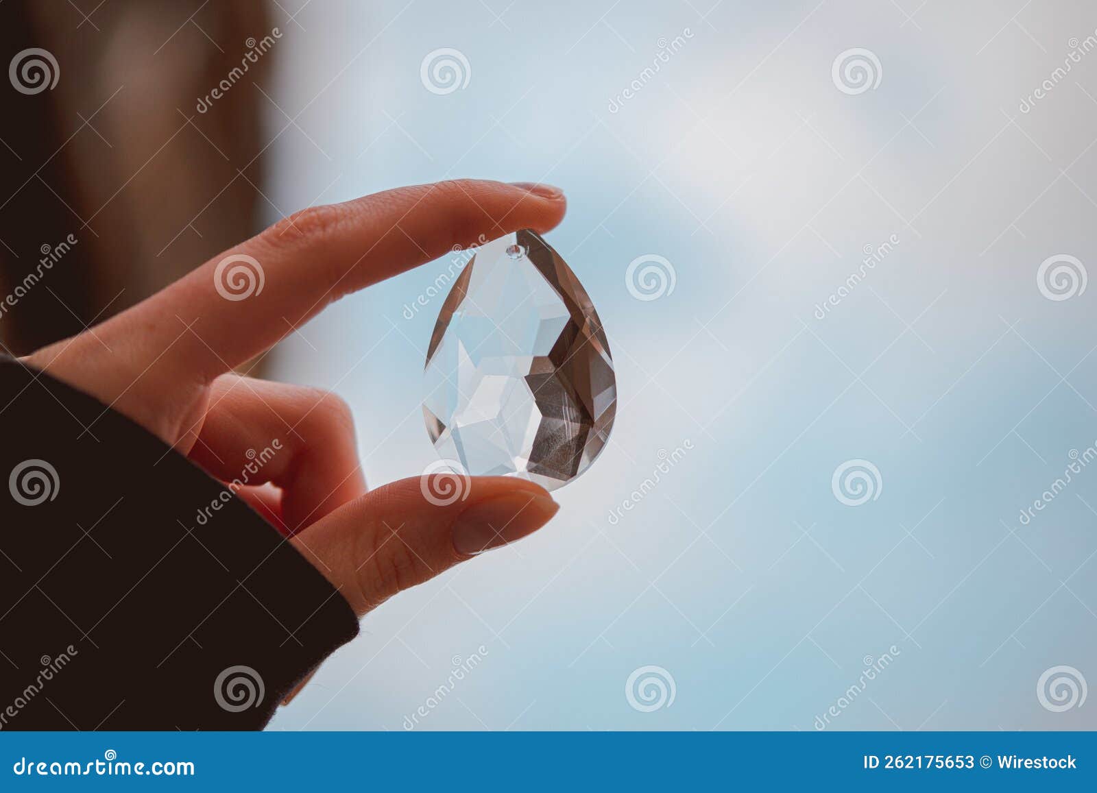 Crystal Teardrop Pendant, Hanging Against Blue Background Royalty-Free ...