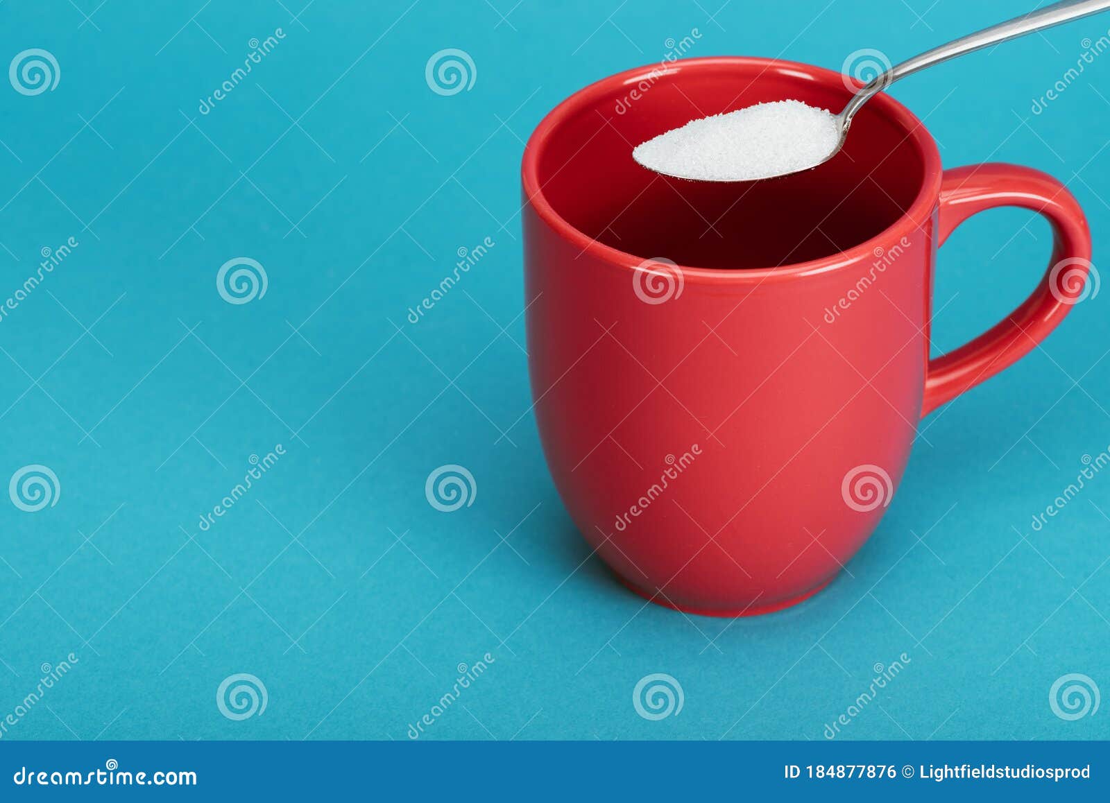 Teaspoonful of White Granulated Sugar Near Red Cup Stock Photo - Image ...