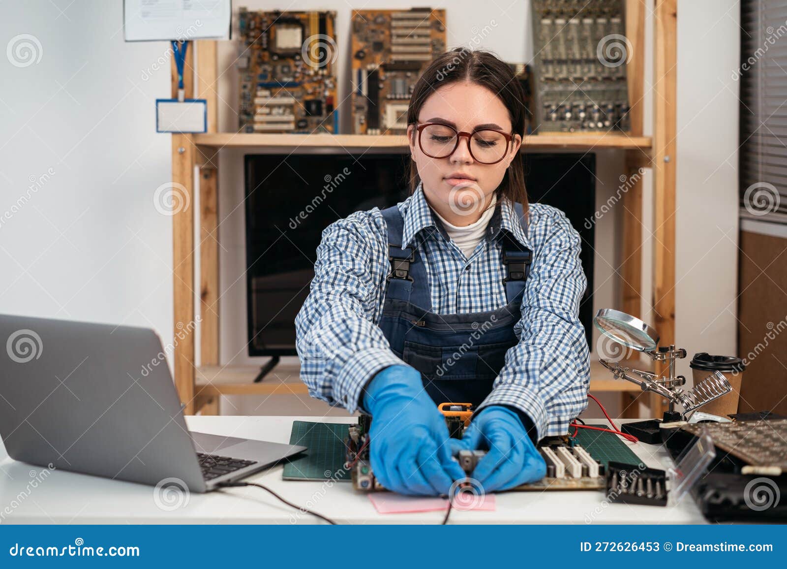 Tech Fixes Motherboard in Service Center. Female Repairman Working with ...