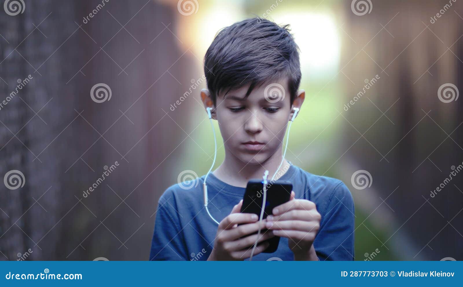 Tech-Savvy Boy Immersed in Music with Phone: Portrait Stock Video ...