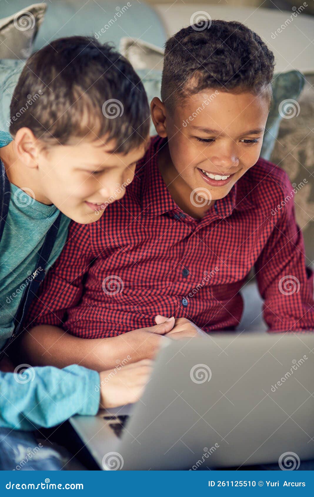 The Tech Savvy Generation. a Two Young Boys Using a Laptop Together at ...