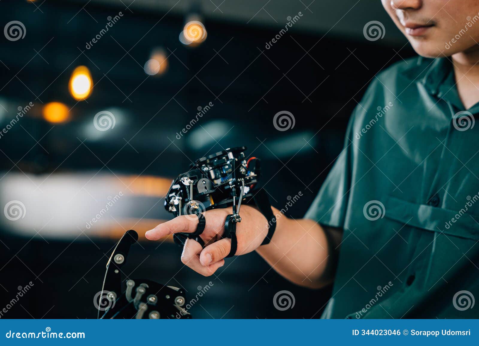 At a Technical College a Teen Boy Tests a Robot Hand and Arm Touching ...