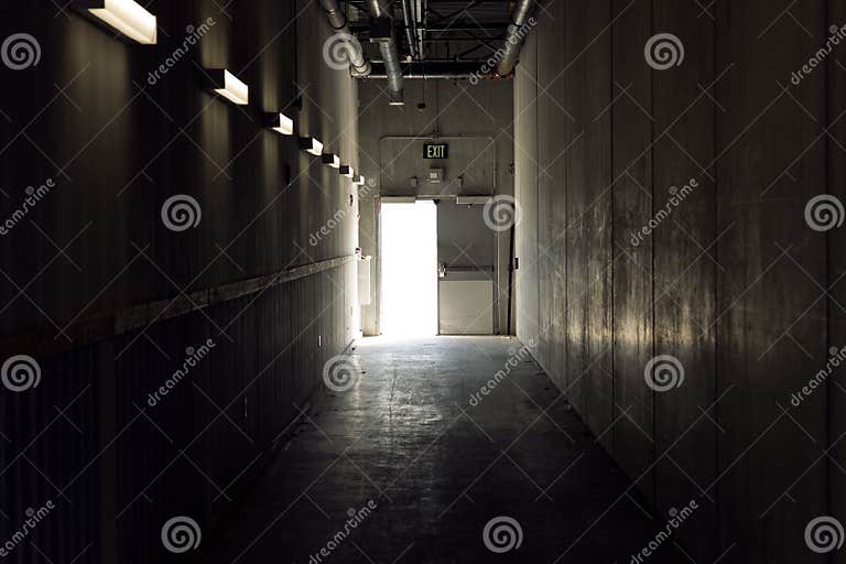 Technical Corridor with Light at the End. Exit Sign Above the Door ...
