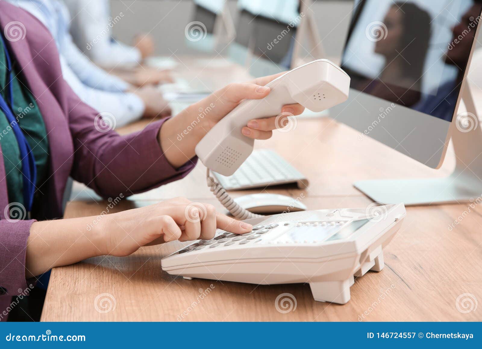 Technical Support Operator Dialing Number on Telephone at Table Stock ...