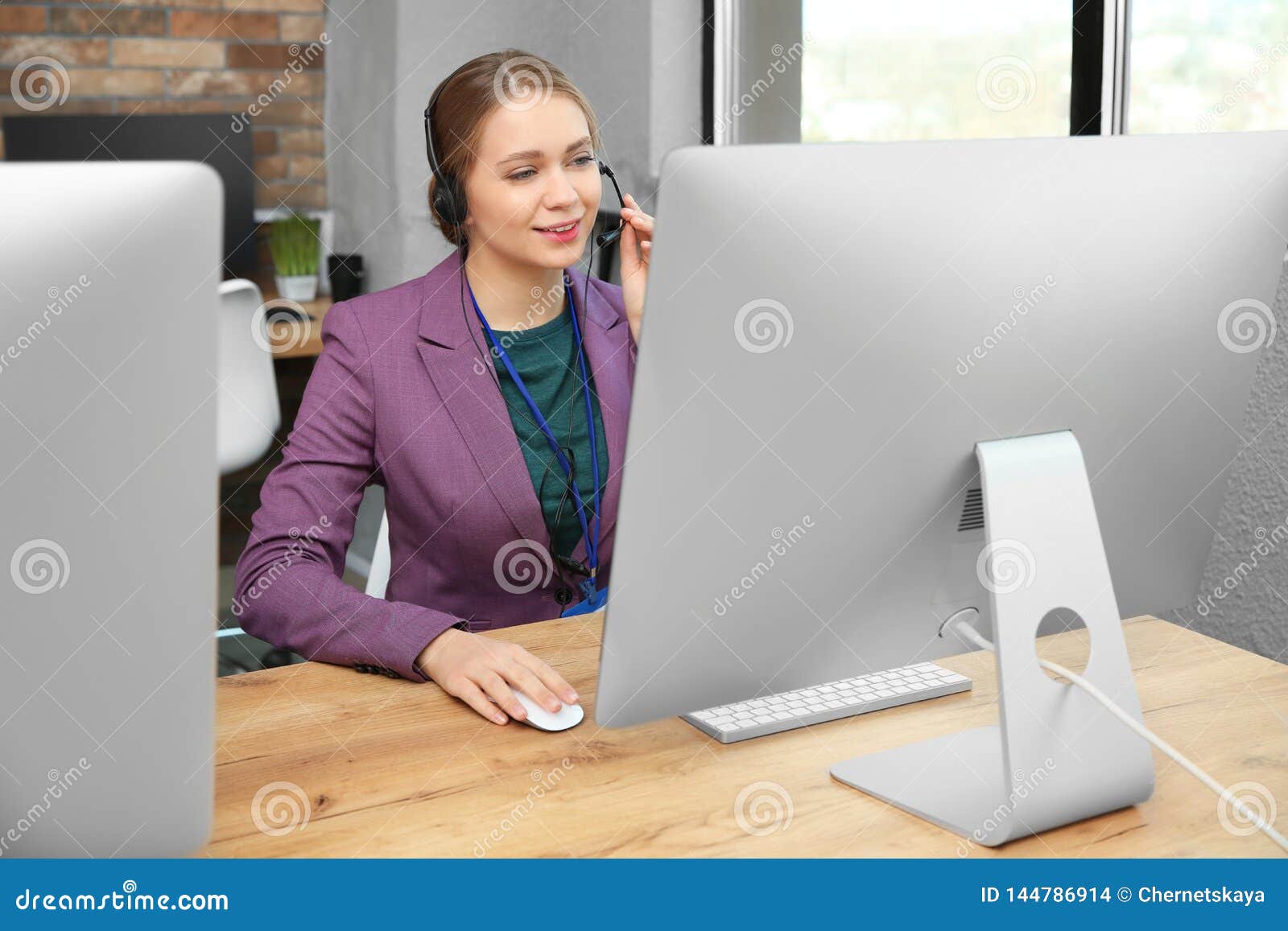 Technical Support Operator Working with Headset and Computer at Table ...