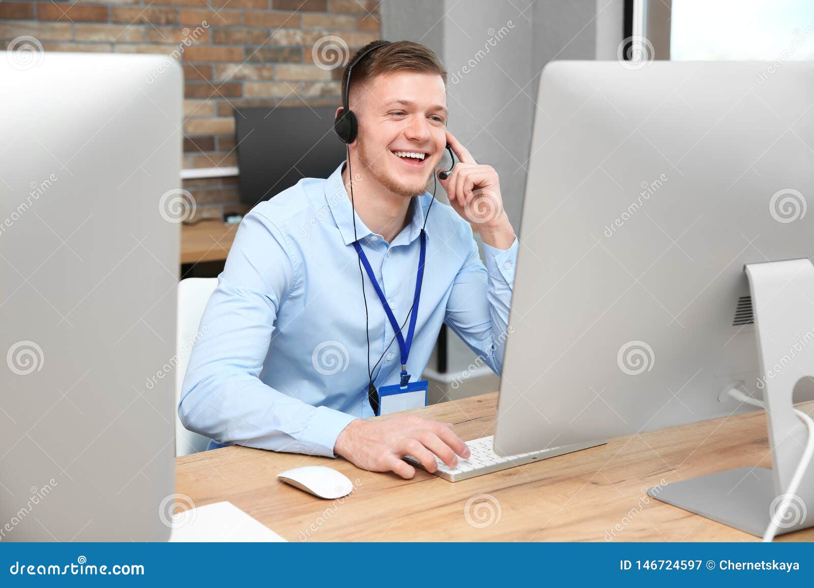 Technical Support Operator Working with Headset and Computer at Table ...
