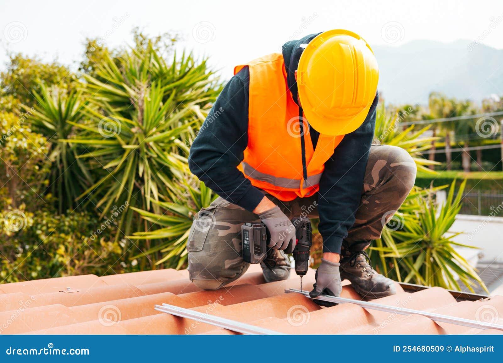 Technical Worker Works with Drill on the Roof of a House Stock Image ...