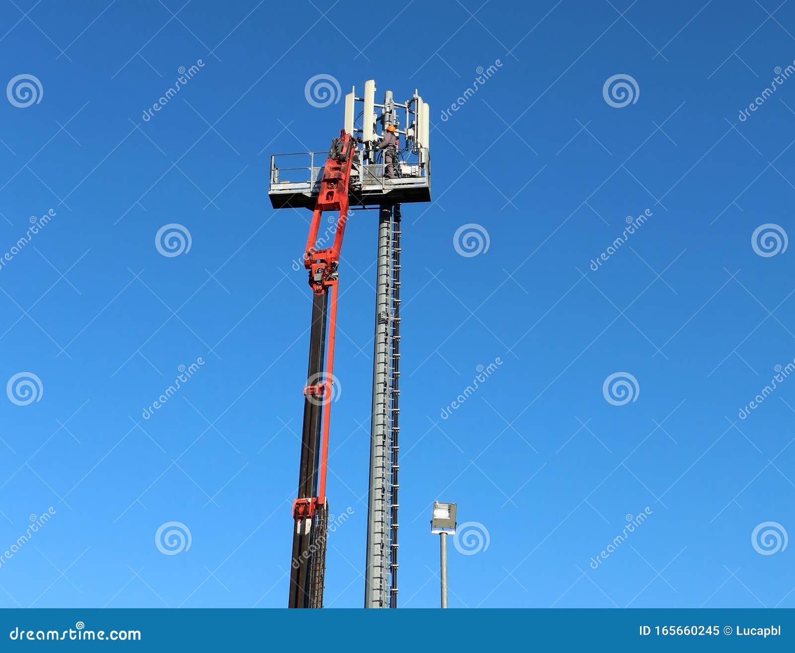 A Technician on an Aerial Platform Does Maintenance of a Cellular Phone ...