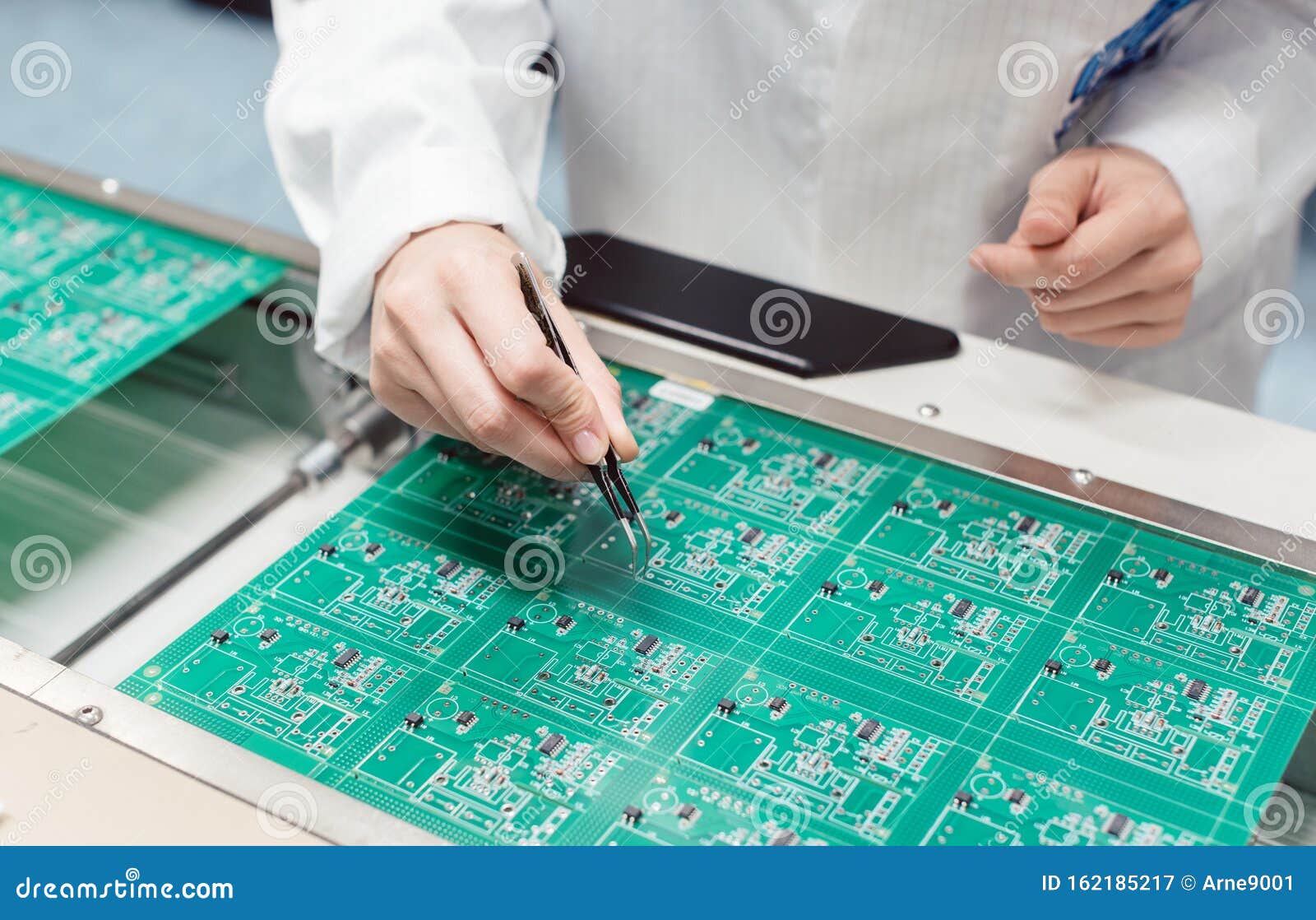 Technician Assembling Electronic Product by Inserting Components into ...