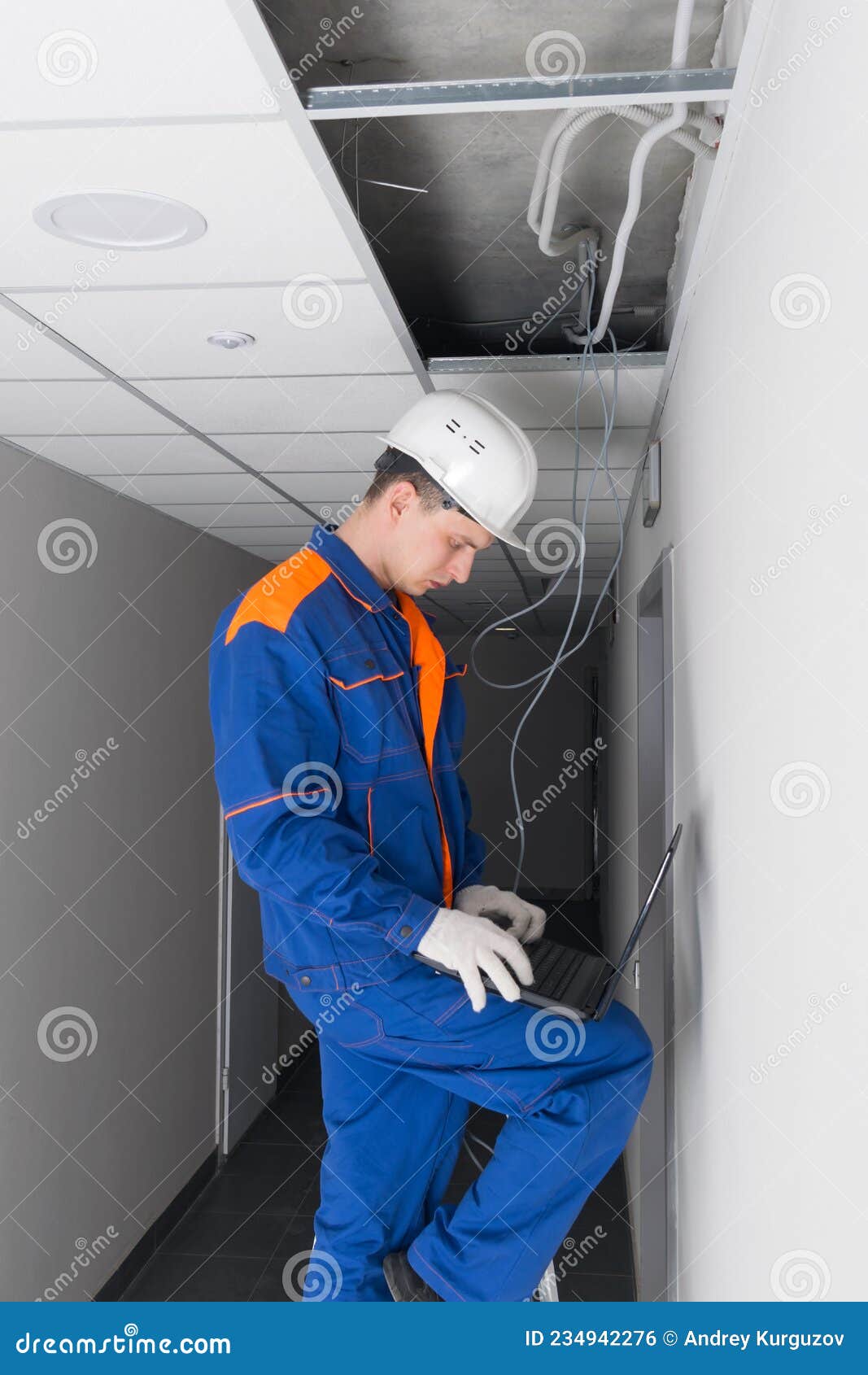 A Technician in a Blue Uniform and a White Helmet, Has Wired the Wifi ...