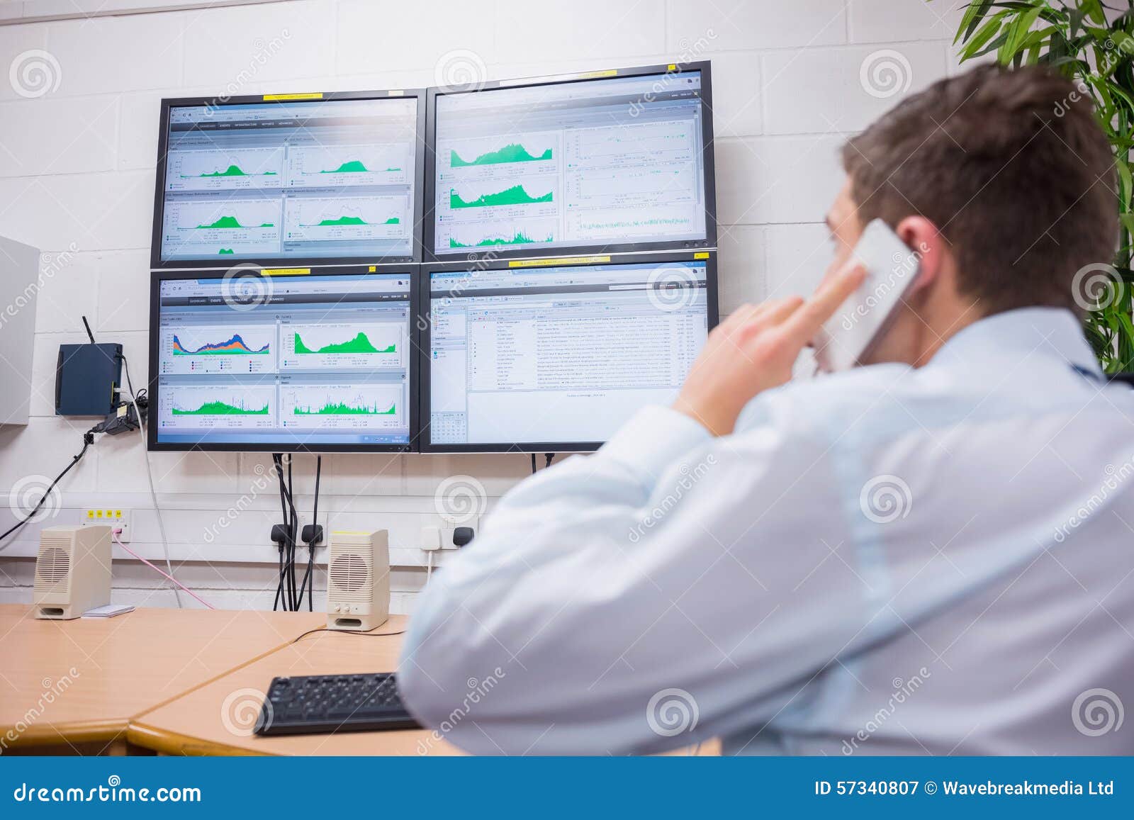 Technician Calling and Looking at Computer Screen Stock Image - Image ...
