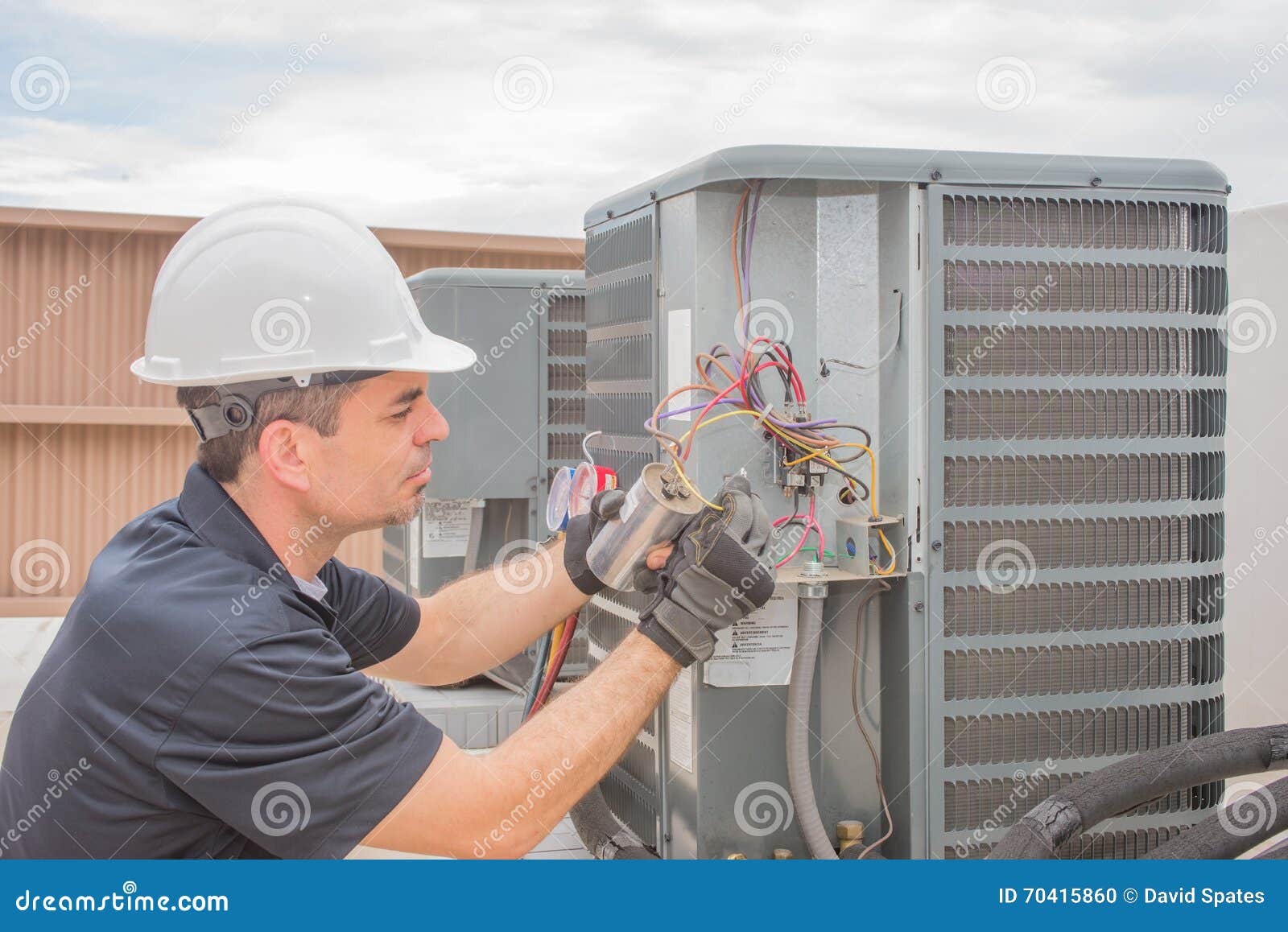 HVAC Technician Is Working On Air Conditioner Units On A Roof Of New ...