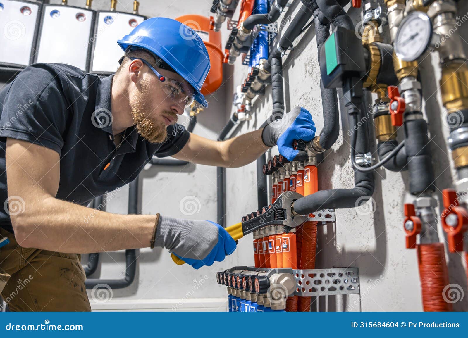 The Technician Checking the Heating System in the Boiler Room. Stock ...