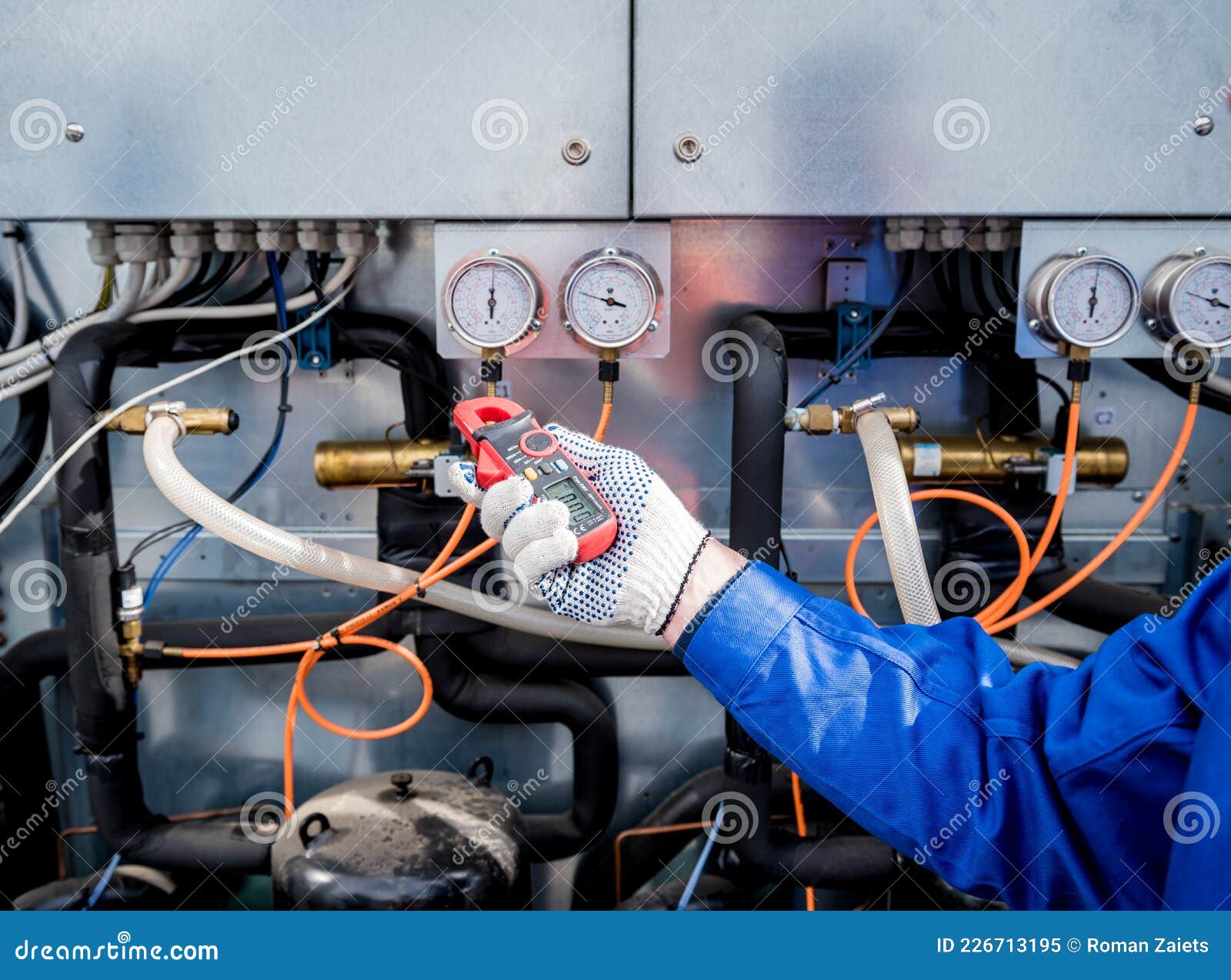 The Technician Checking Power Lines of the Heat Exchanger with Current ...