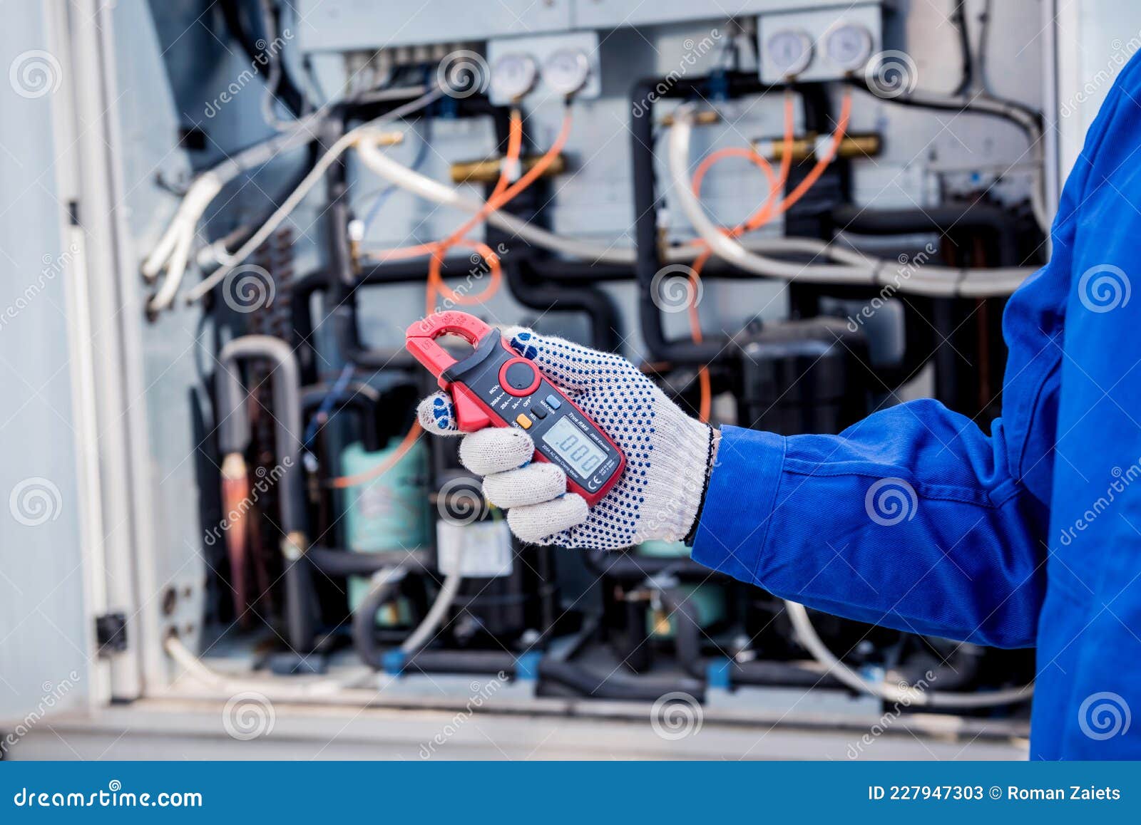 The Technician Checking Power Lines of the Heat Exchanger with Current ...