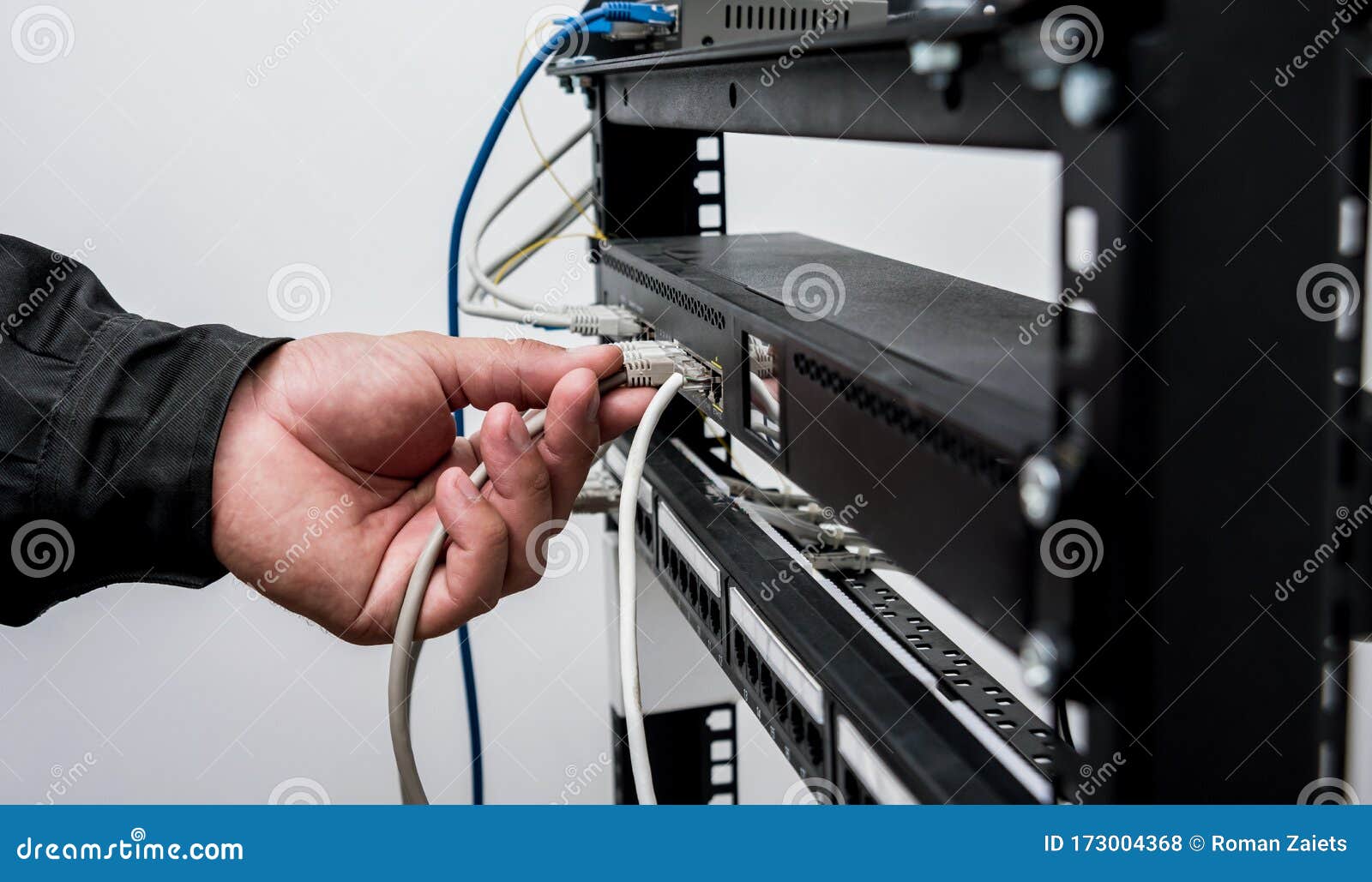Technician Connecting Network Cables To Switches. Connecting Cables ...