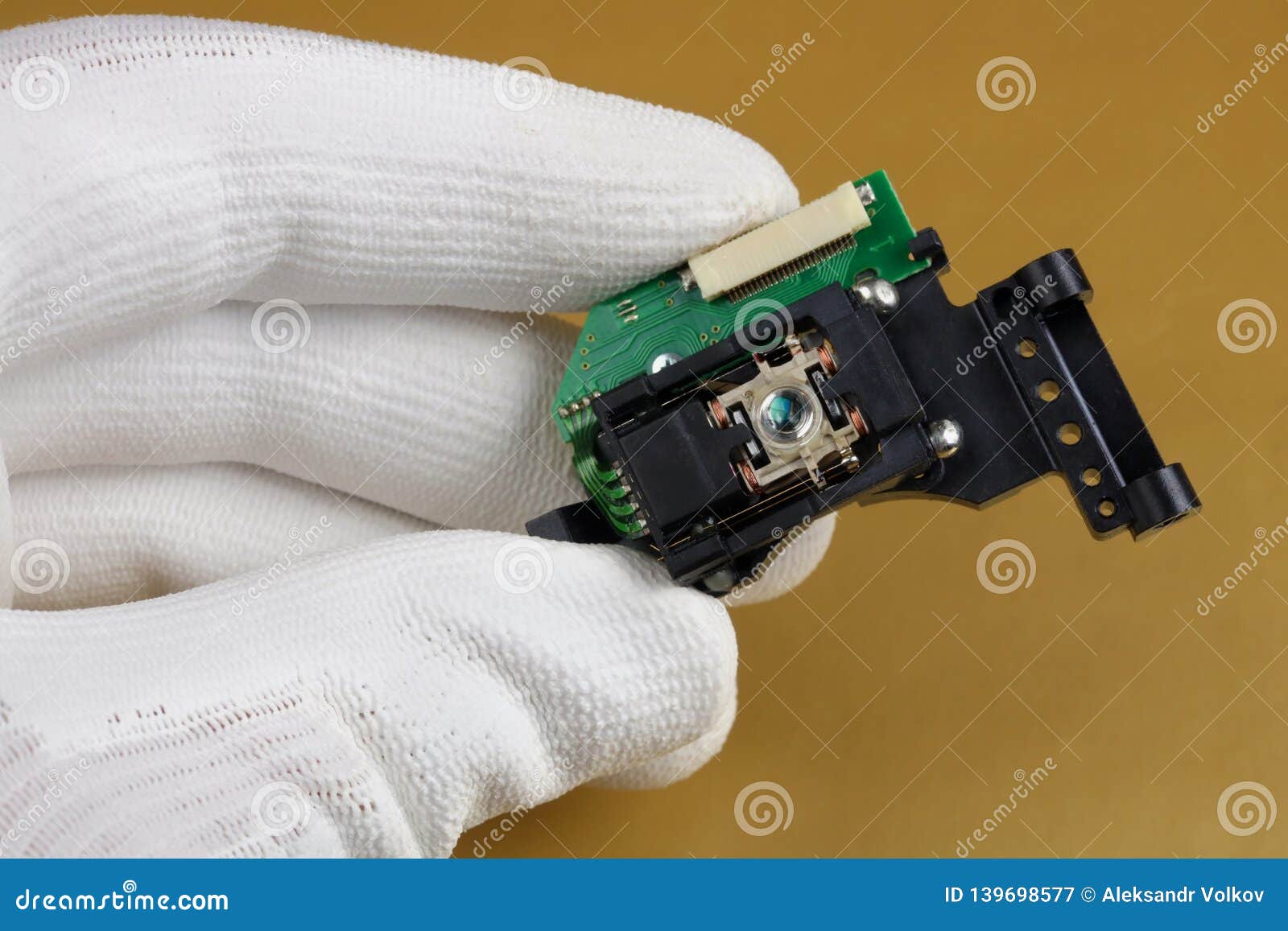 A Technician Controls the Quality of a Laser Unit for Mobile Audio ...