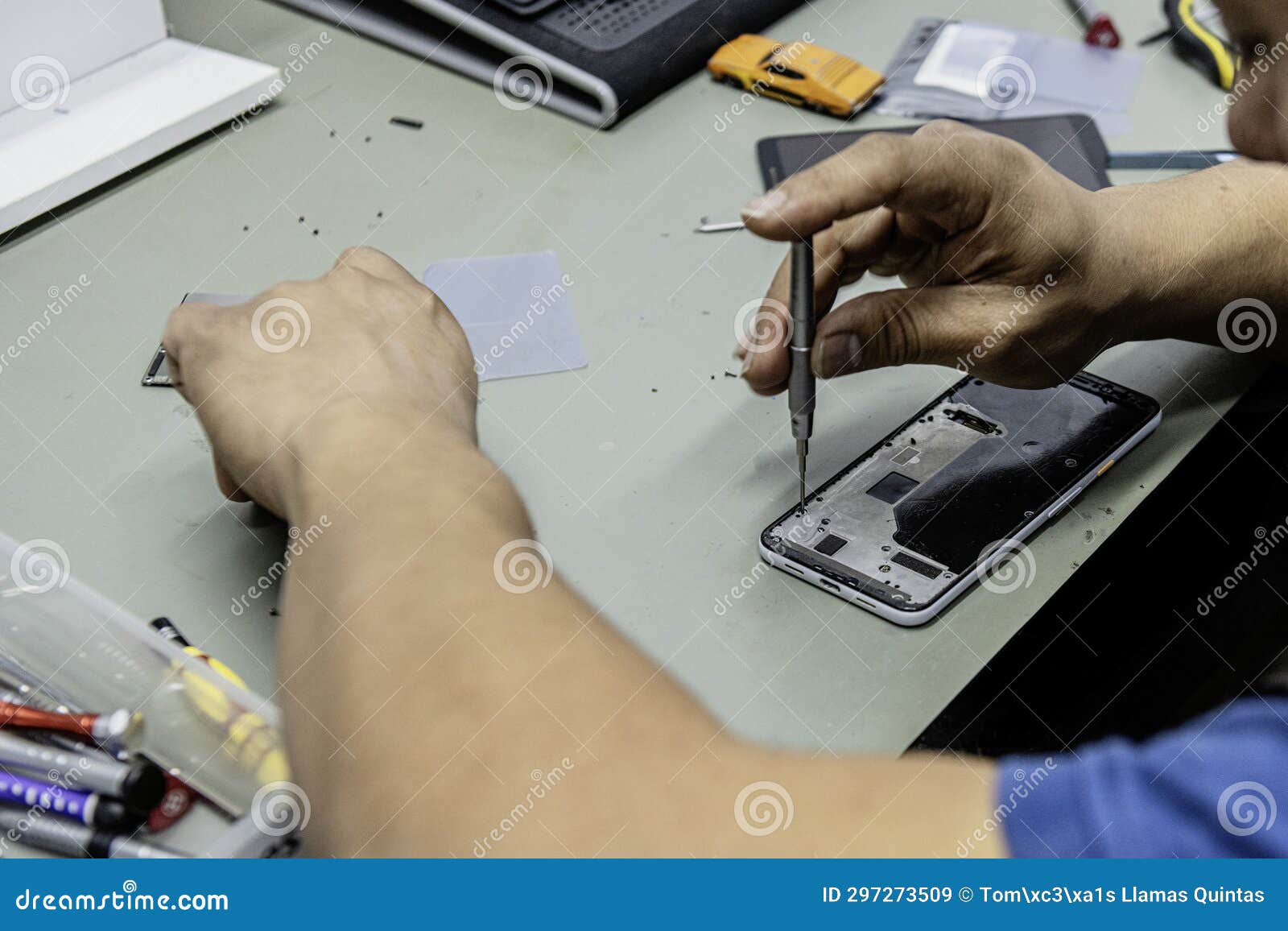 A Technician Disassembling the Inside of a Telephone on His Workshop ...