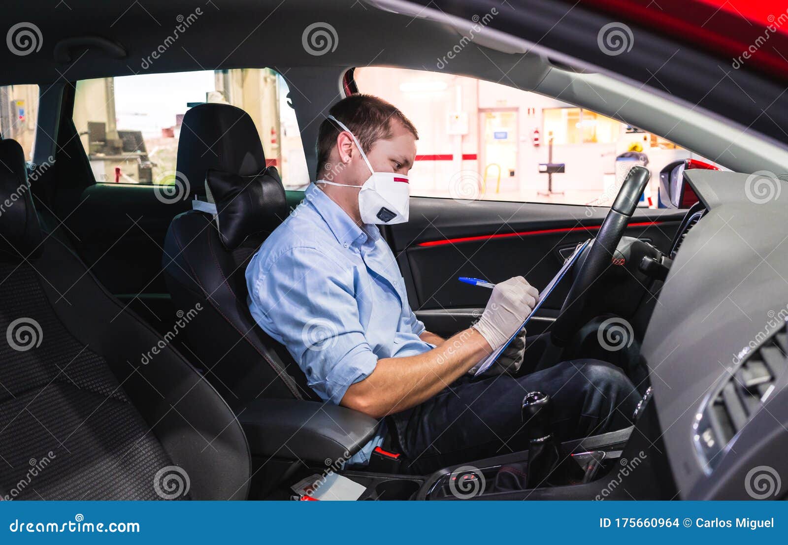 Technician Doing a Security Inspection Inside a Vehicle Protected with ...