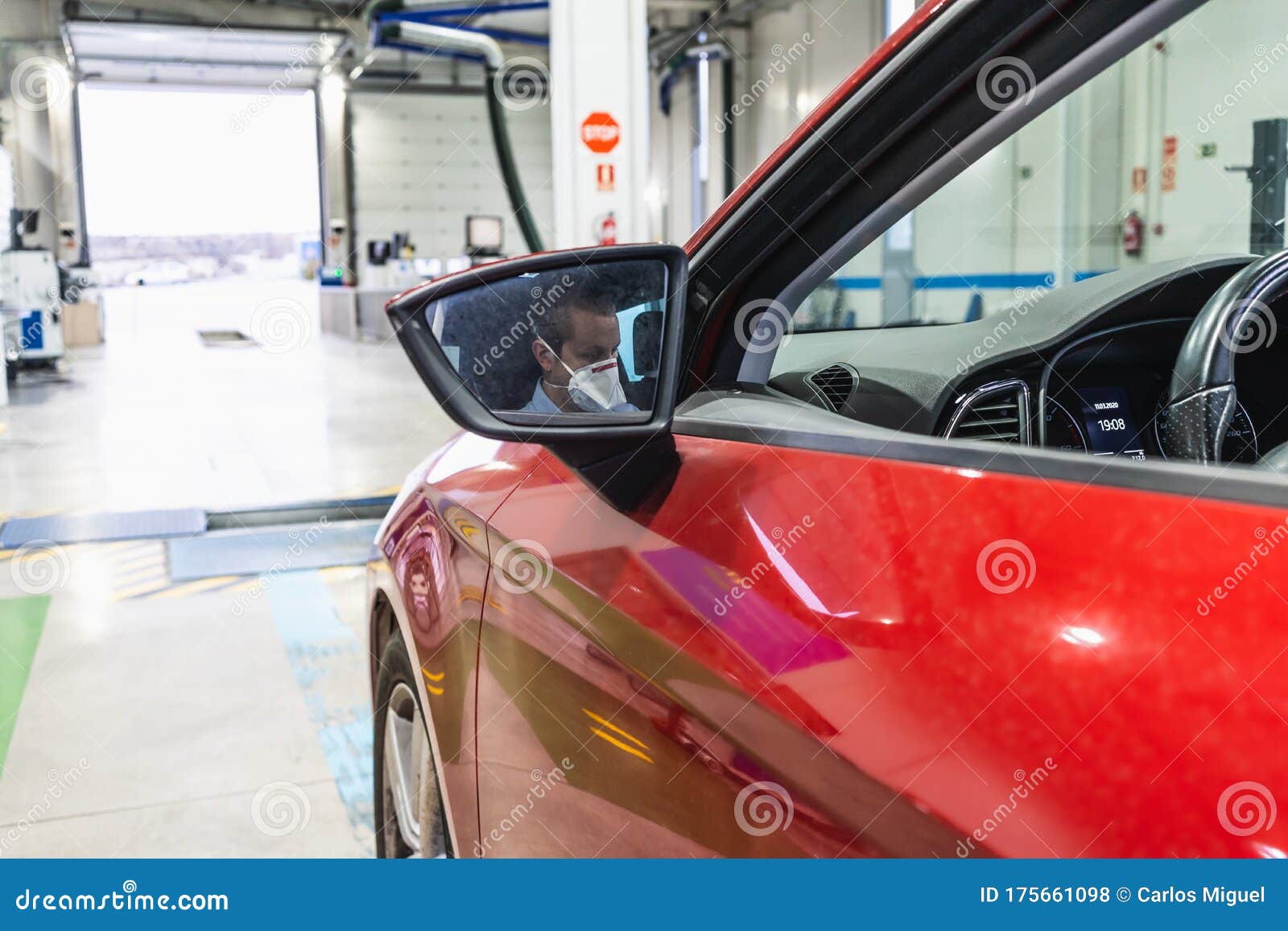 Technician Doing a Security Inspection Inside a Vehicle Protected with ...