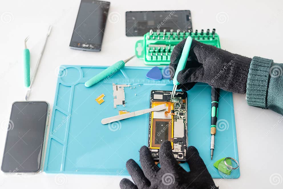 Technician or Engineer Disassembling Components Broken Smartphone and ...