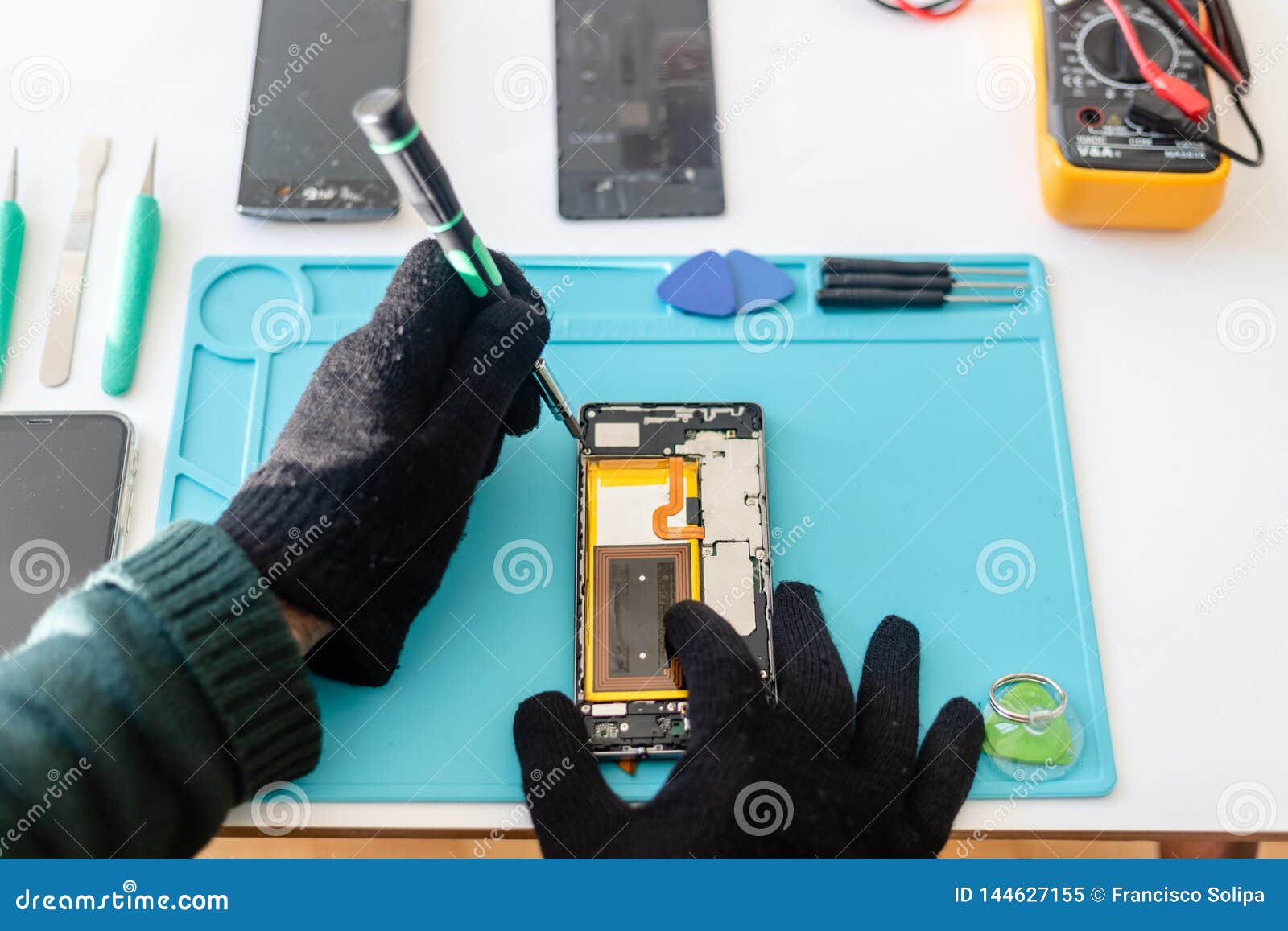 Technician or Engineer Disassembling Components Broken Smartphone and ...