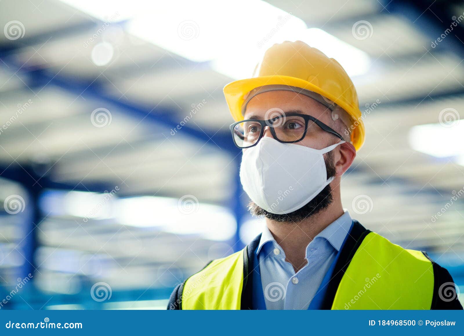 Technician or Engineer with Protective Mask and Helmet Standing in ...