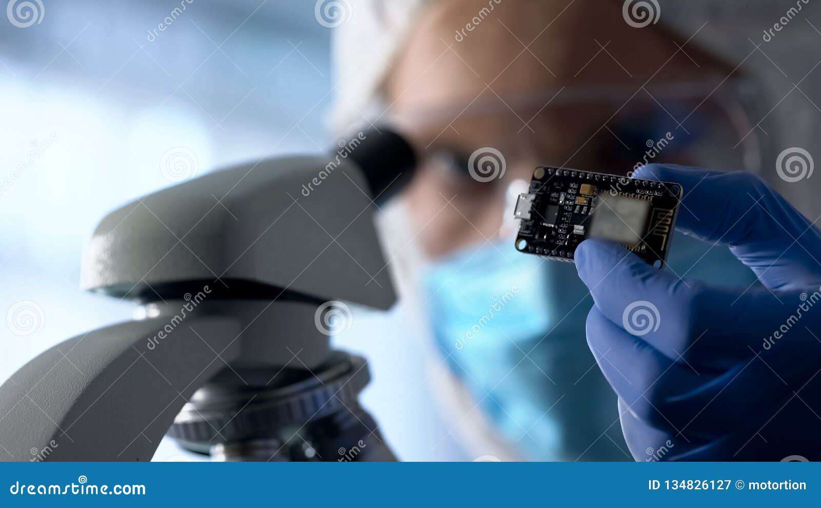 Technician Examining Chip, Using Microscope To Run Diagnosis and ...