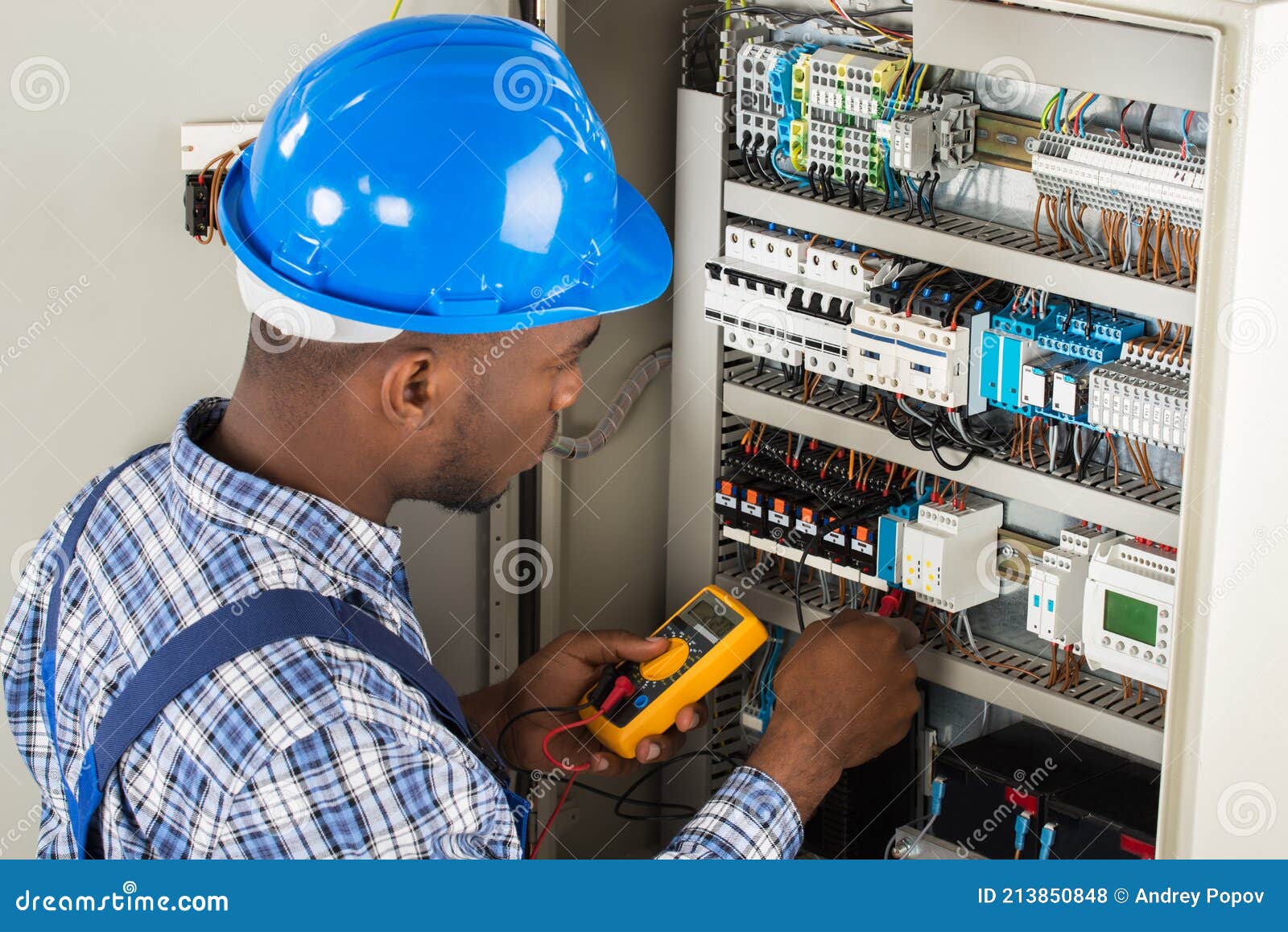 Technician Examining Fusebox with Multimeter Probe Stock Photo - Image ...
