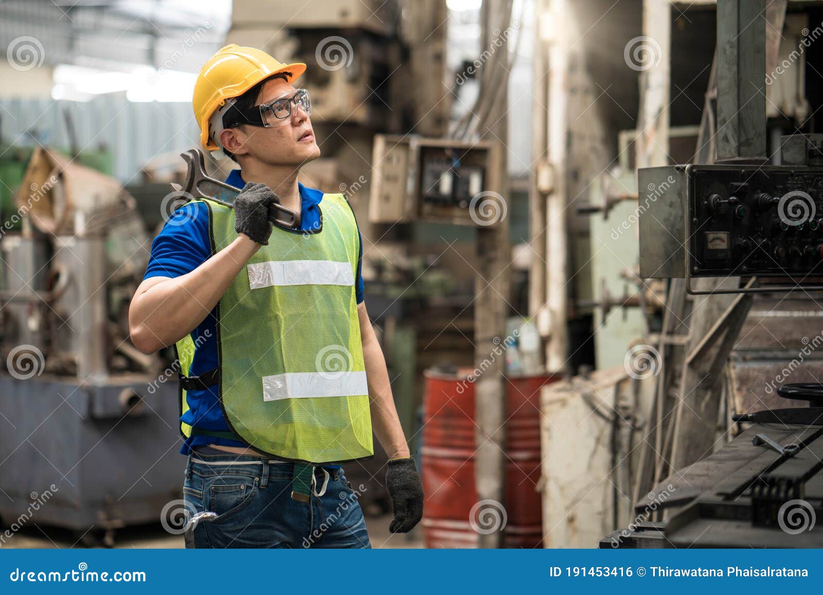 The Technician in the Factory is Maintaining the Machine. the ...