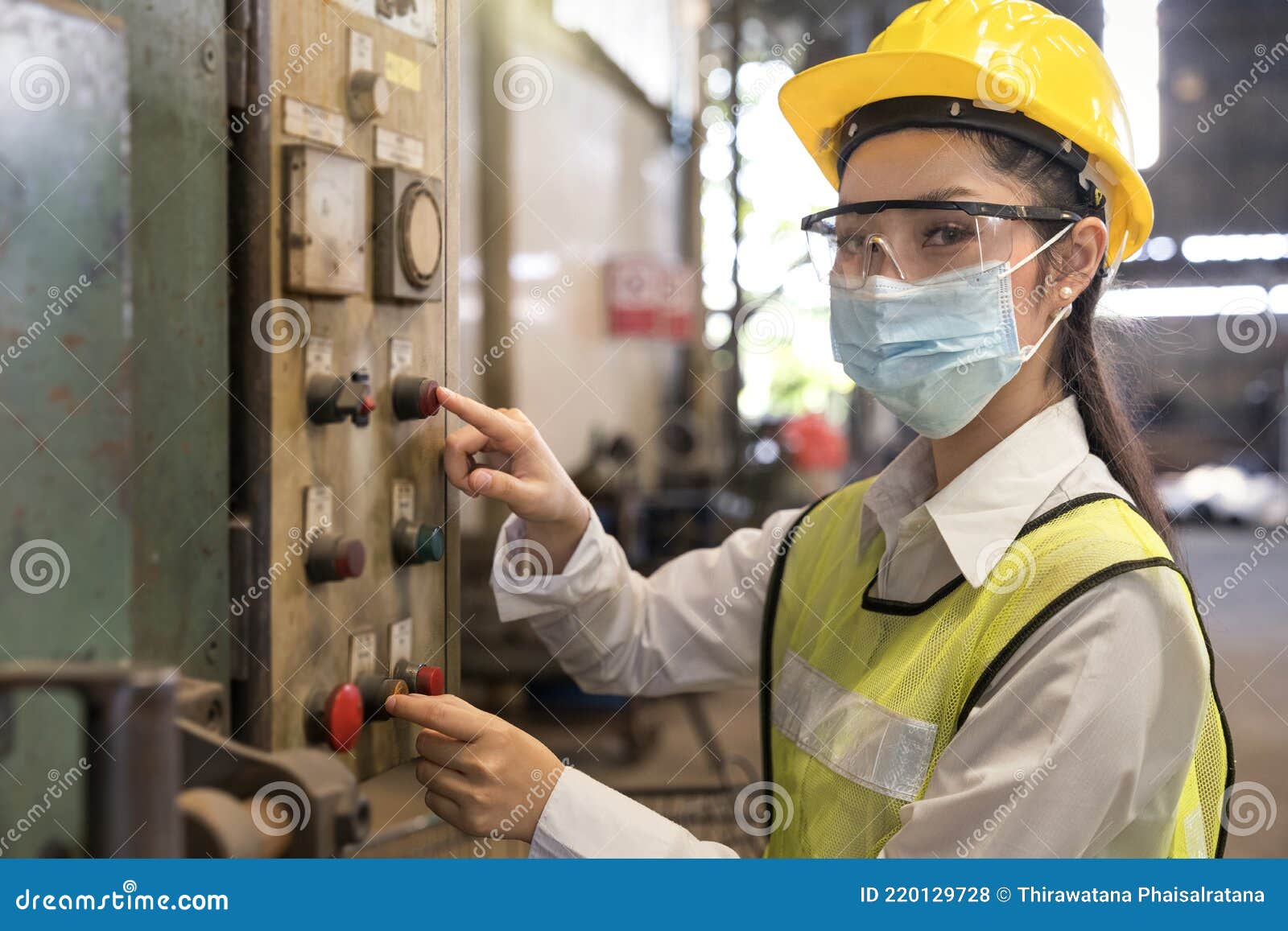 A Technician or Female Engineer Wearing a Mask is Operating the Machine ...