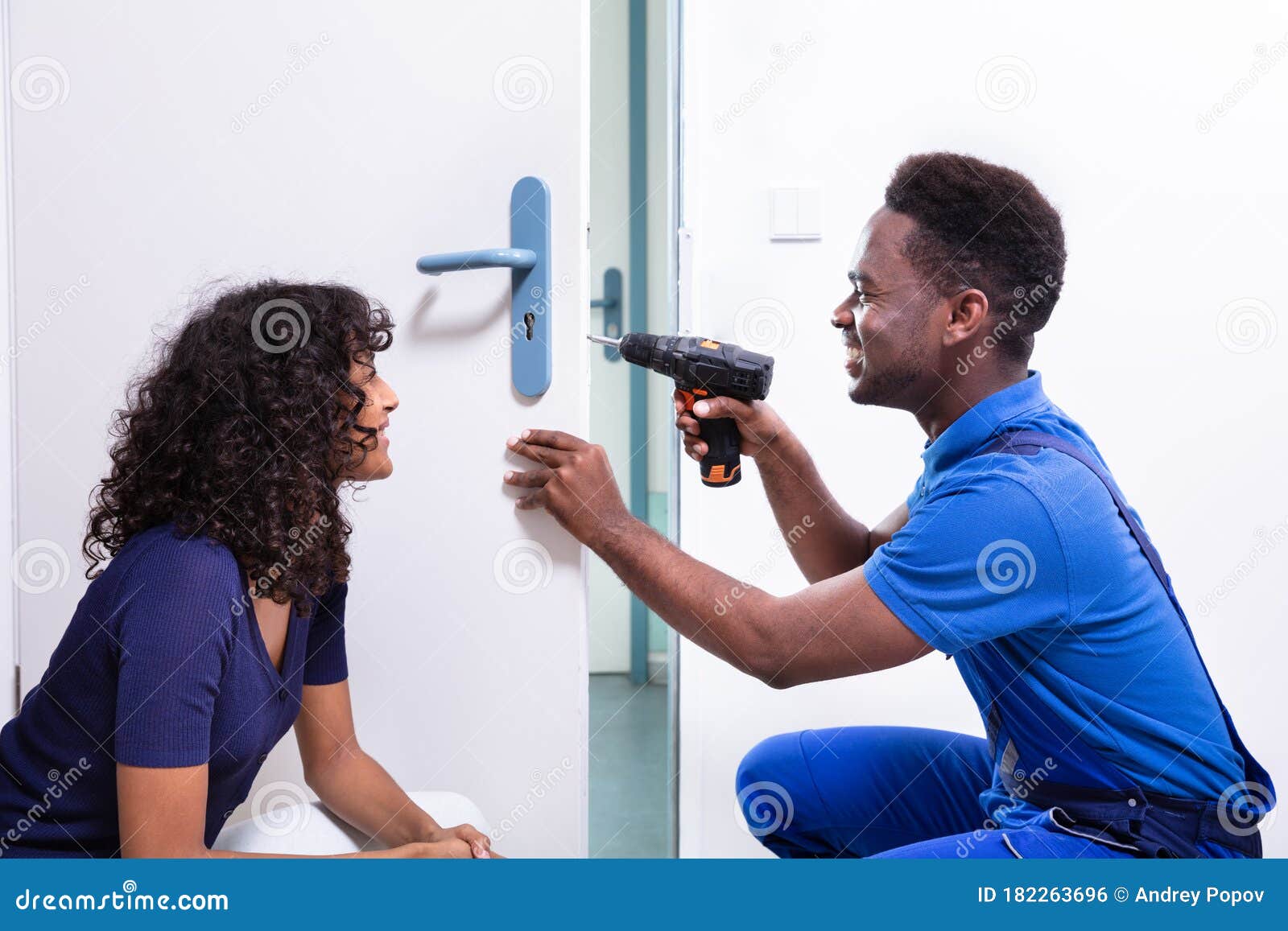 Technician Fixing the Door Lock Stock Photo - Image of indoors, door ...