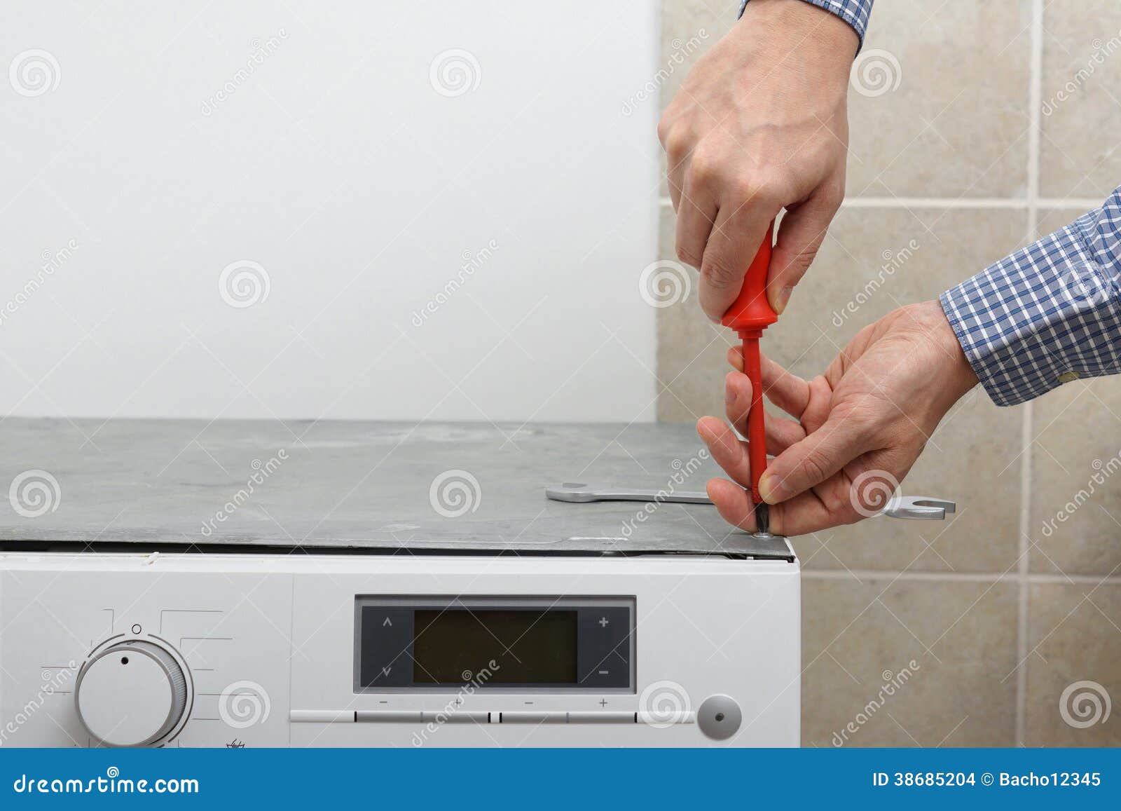 Technician Fixing Washing Machine with Screwdriver Stock Photo - Image ...