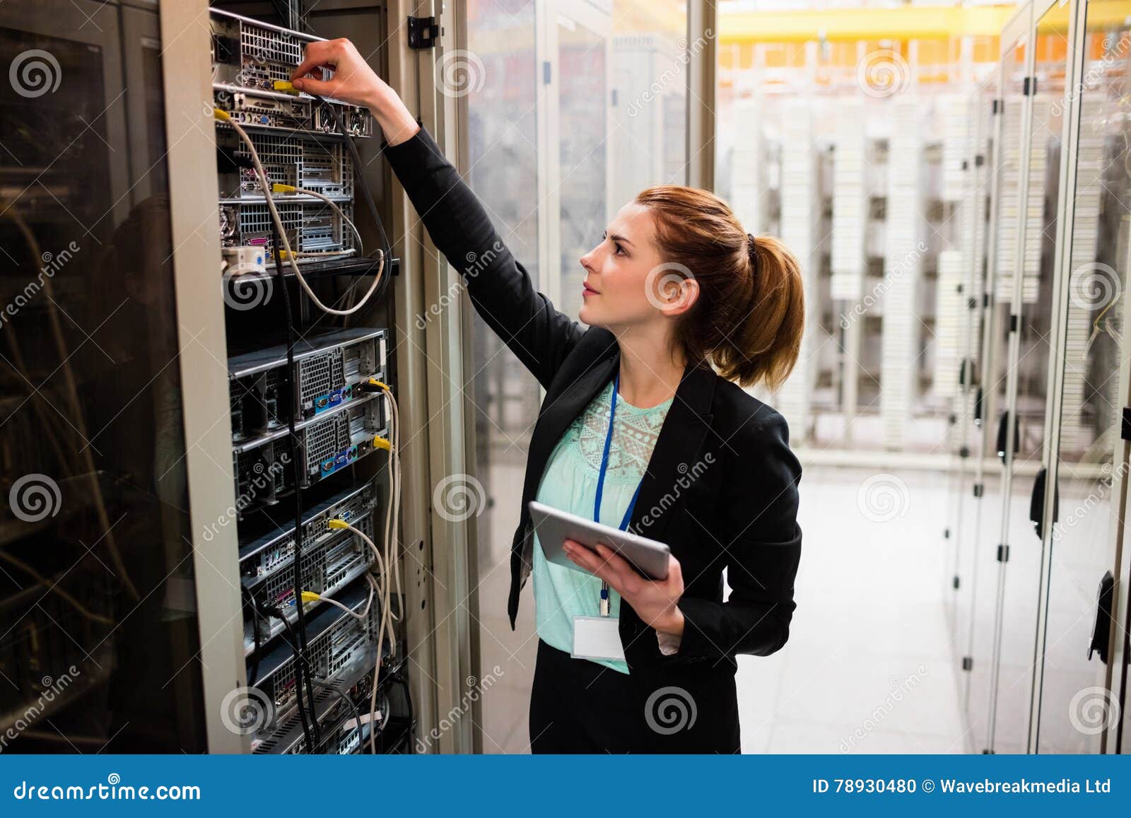 Technician Holding Digital Tablet while Examining Server Stock Photo ...