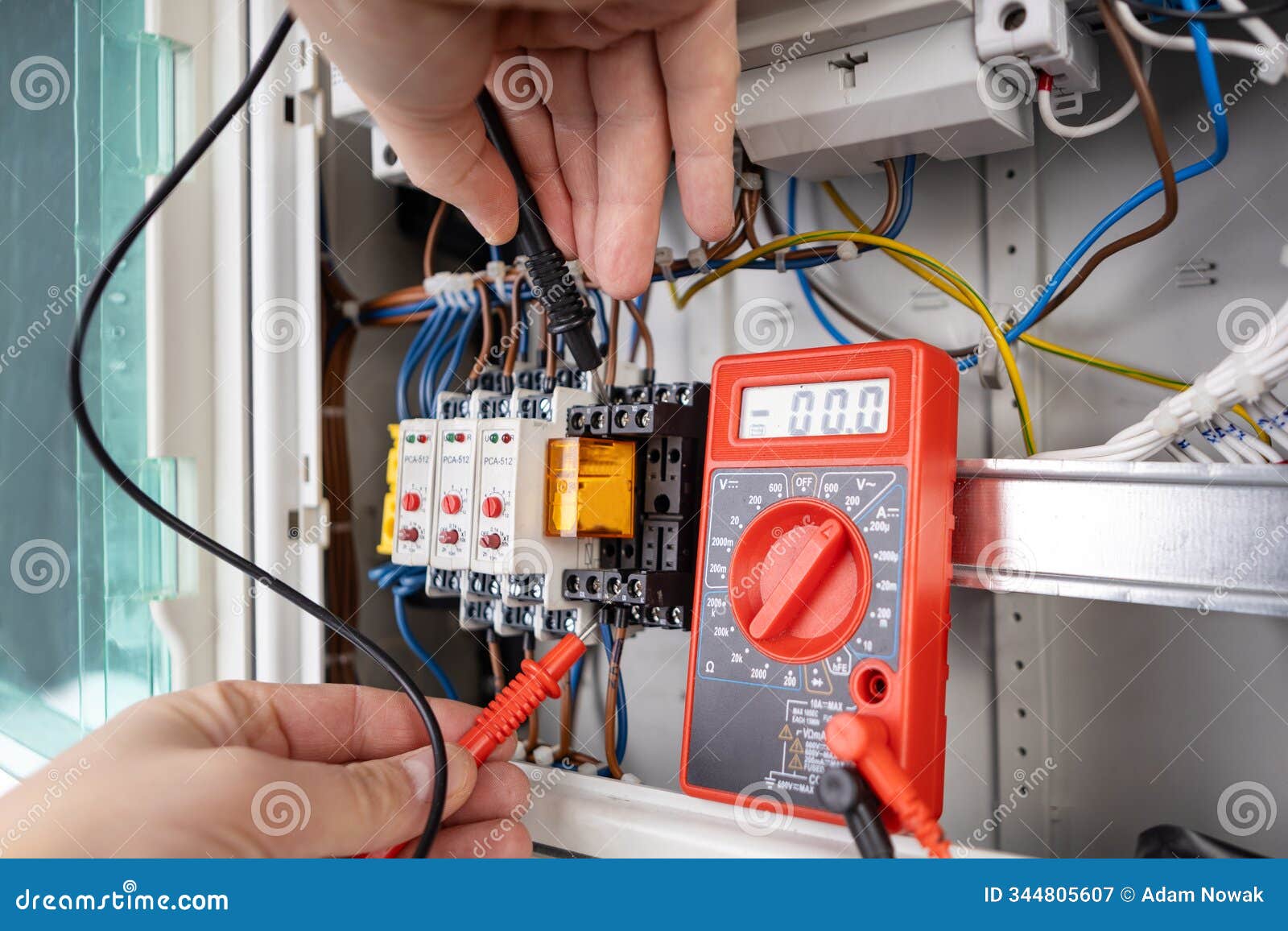 Technician Holding Probes for Circuit Testing with Multimeter Stock ...